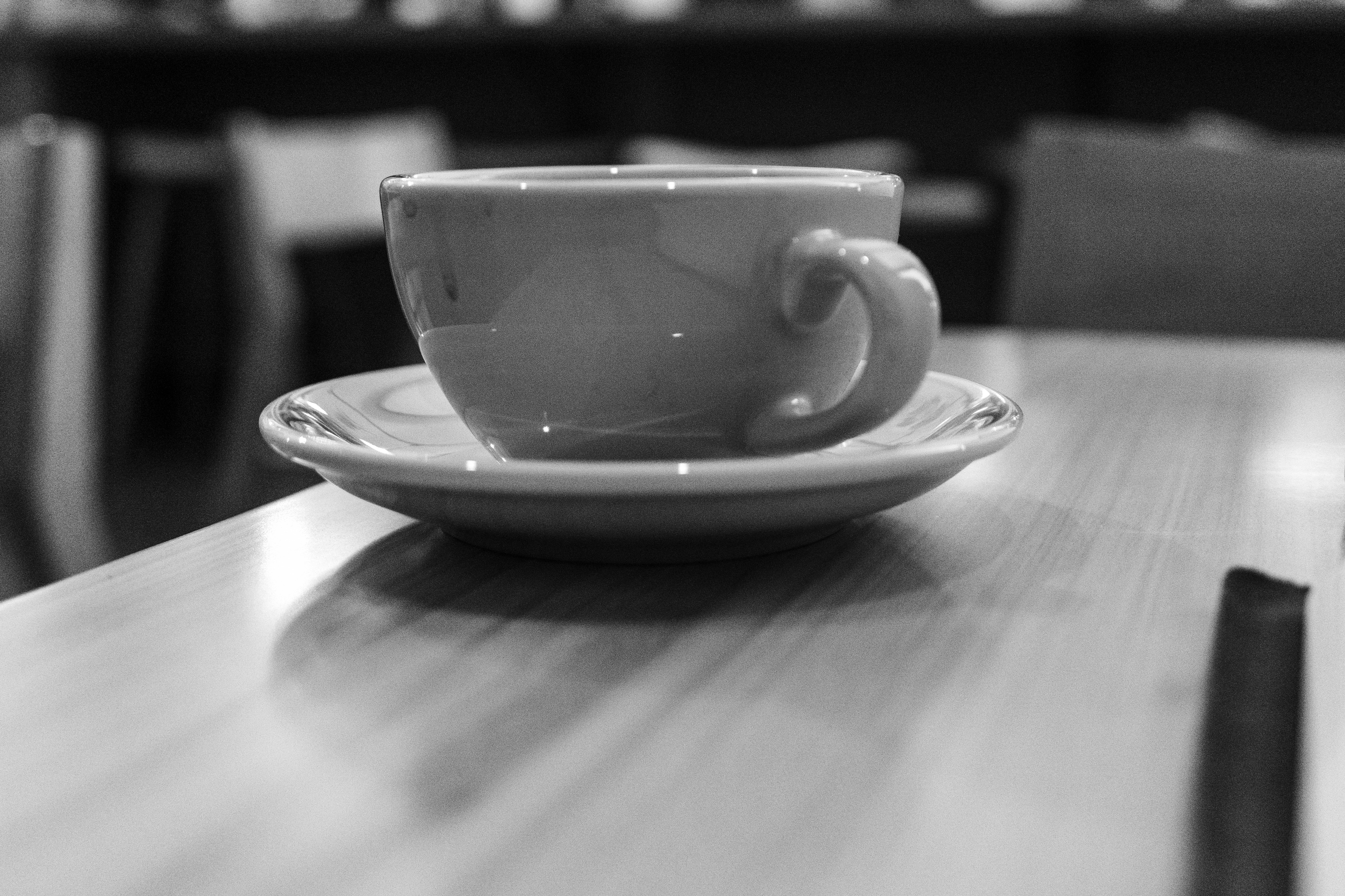 A black and white close-up of a coffee cup.