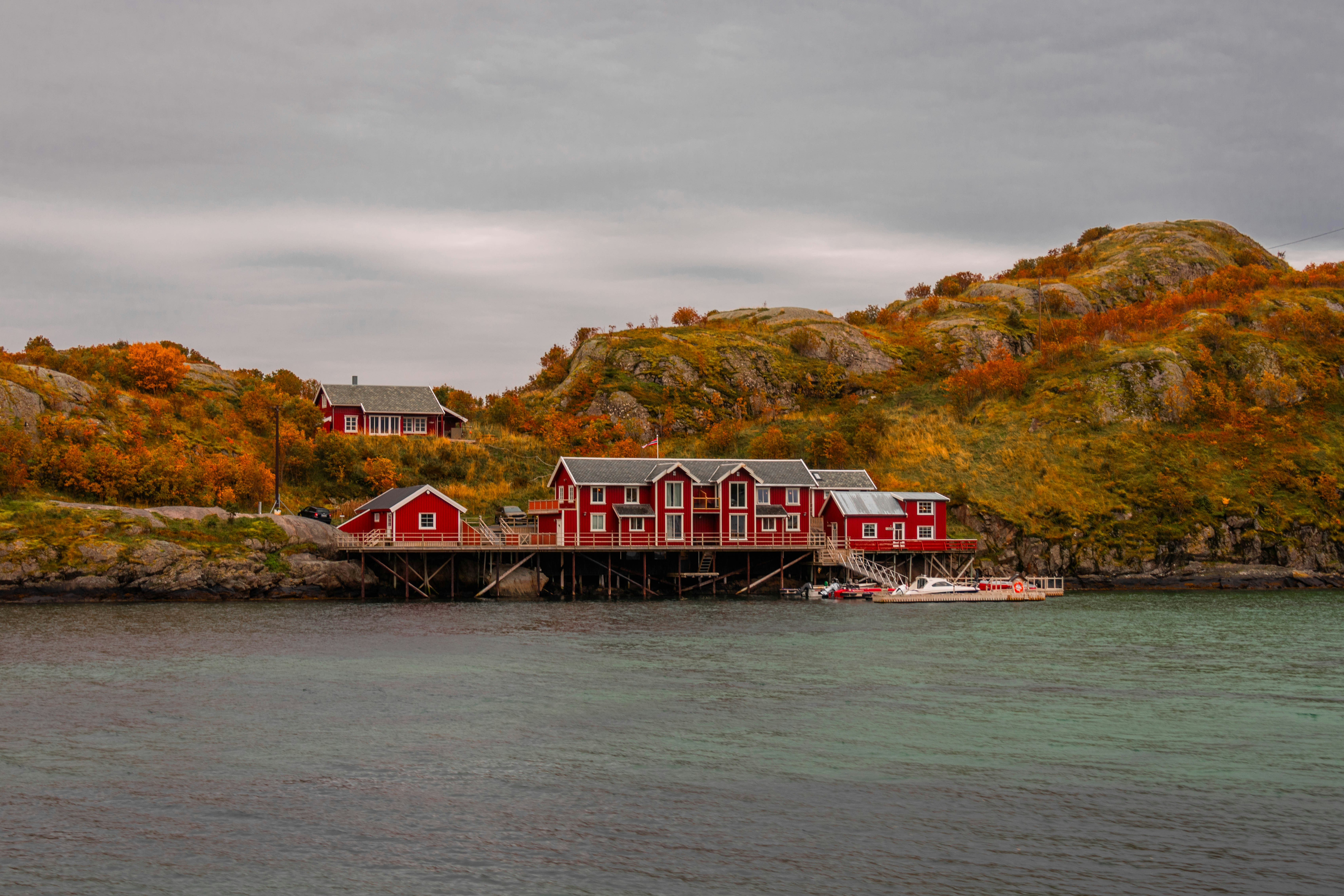 Stilted Red Village Beneath Autumn Hills