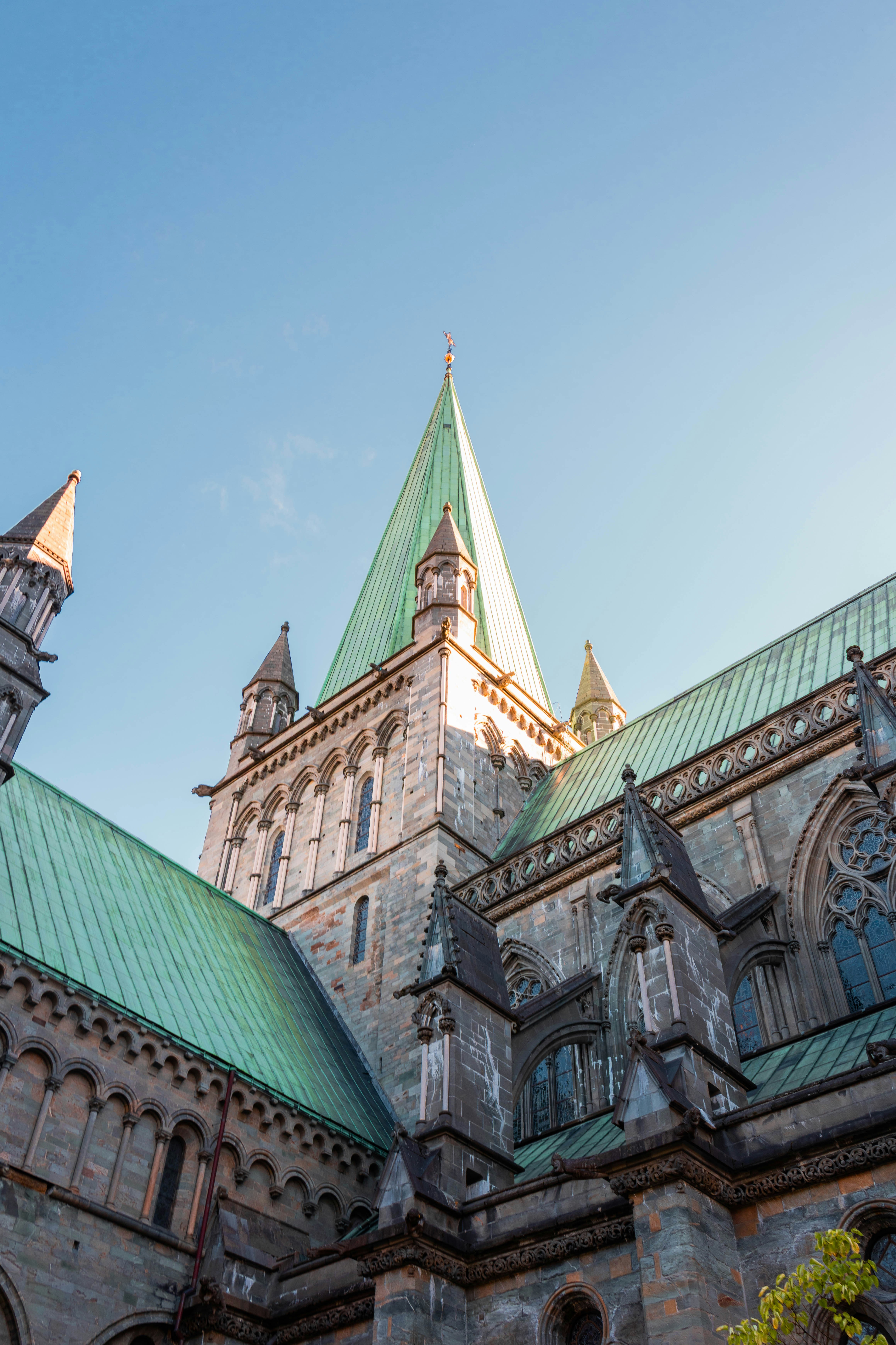 Gothic cathedral with green copper roof under blue sky