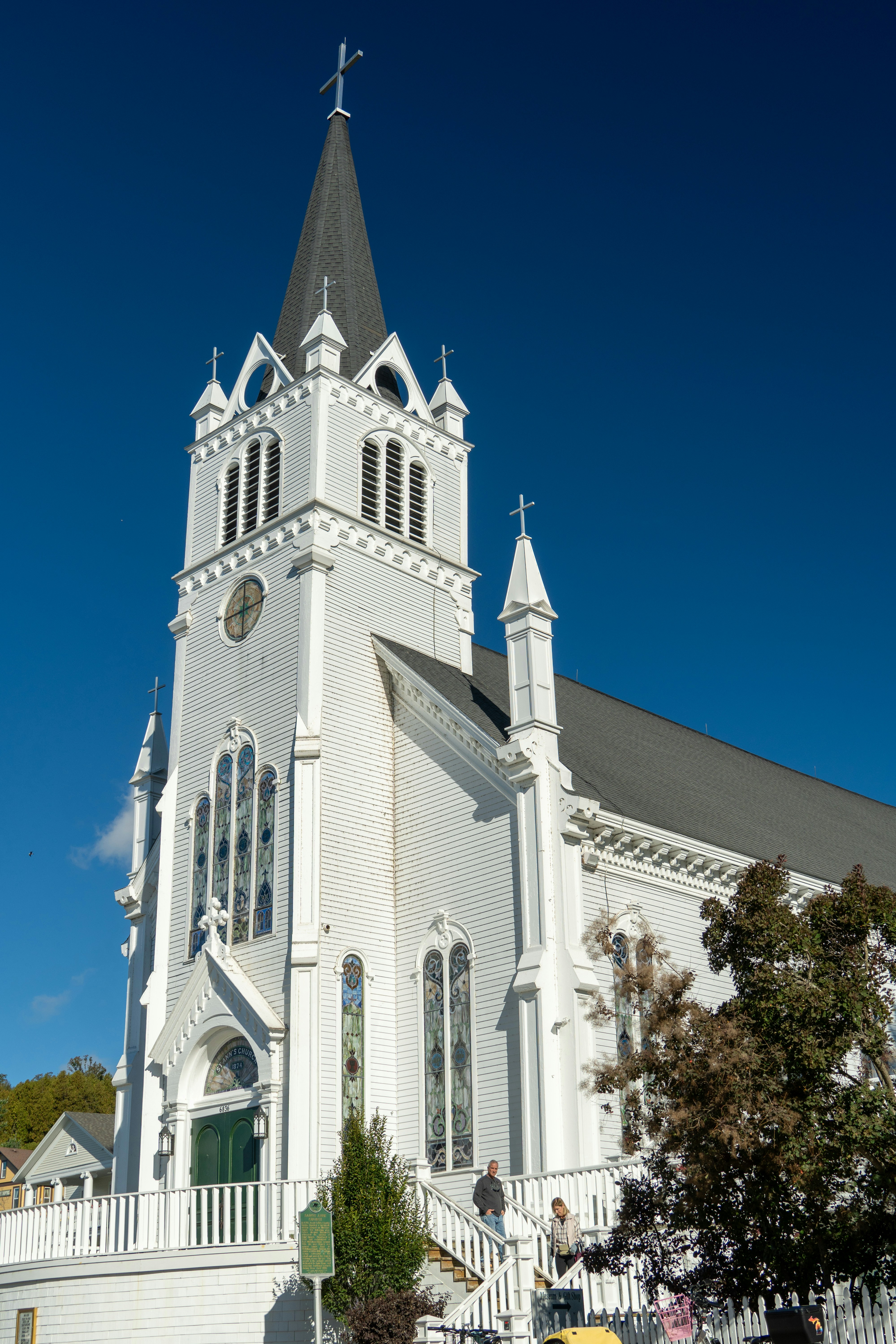 White church with a tall steeple under blue sky