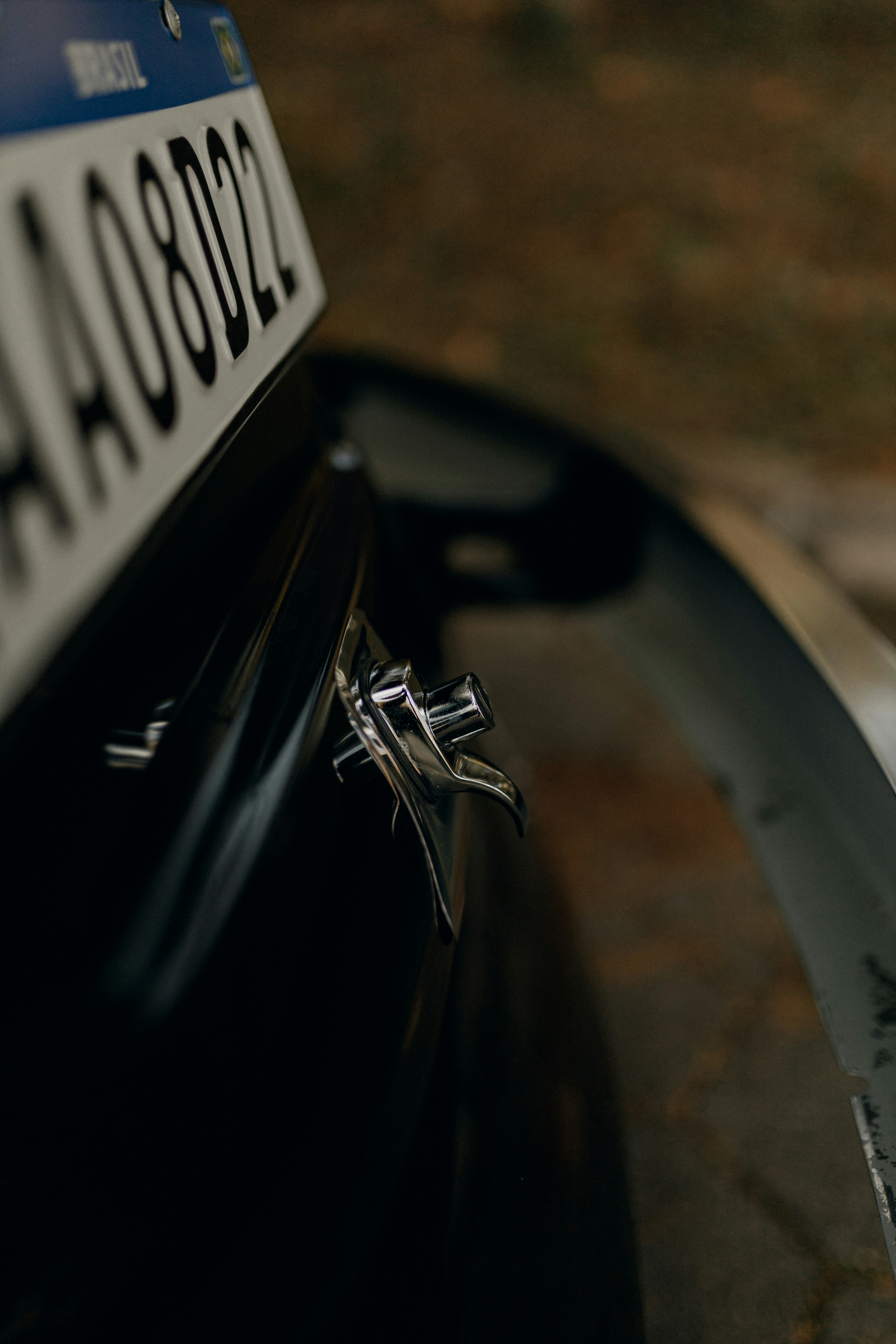Close-up of a car's license plate and bumper