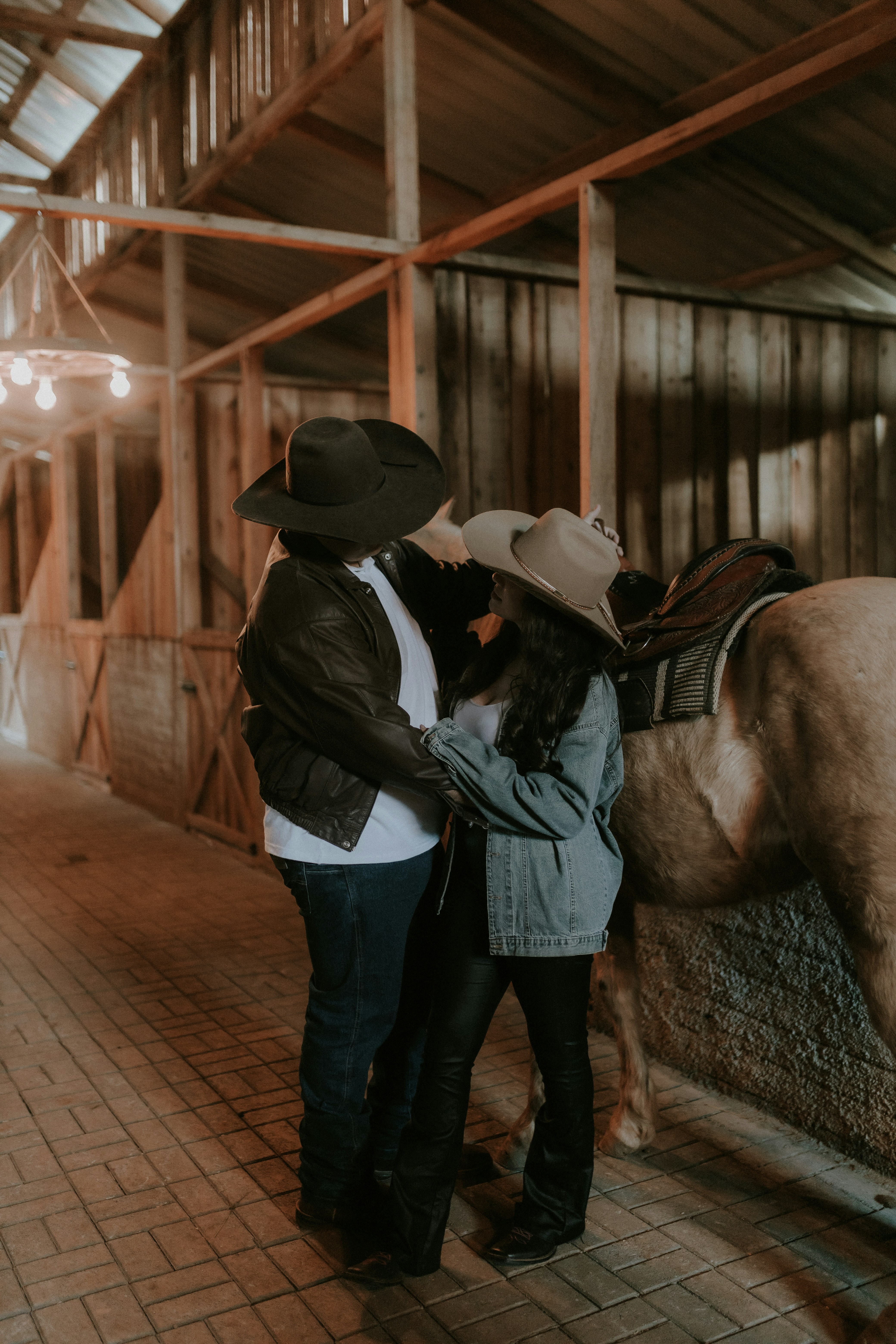 Under Barn Glow: A Quiet Embrace by the Stall