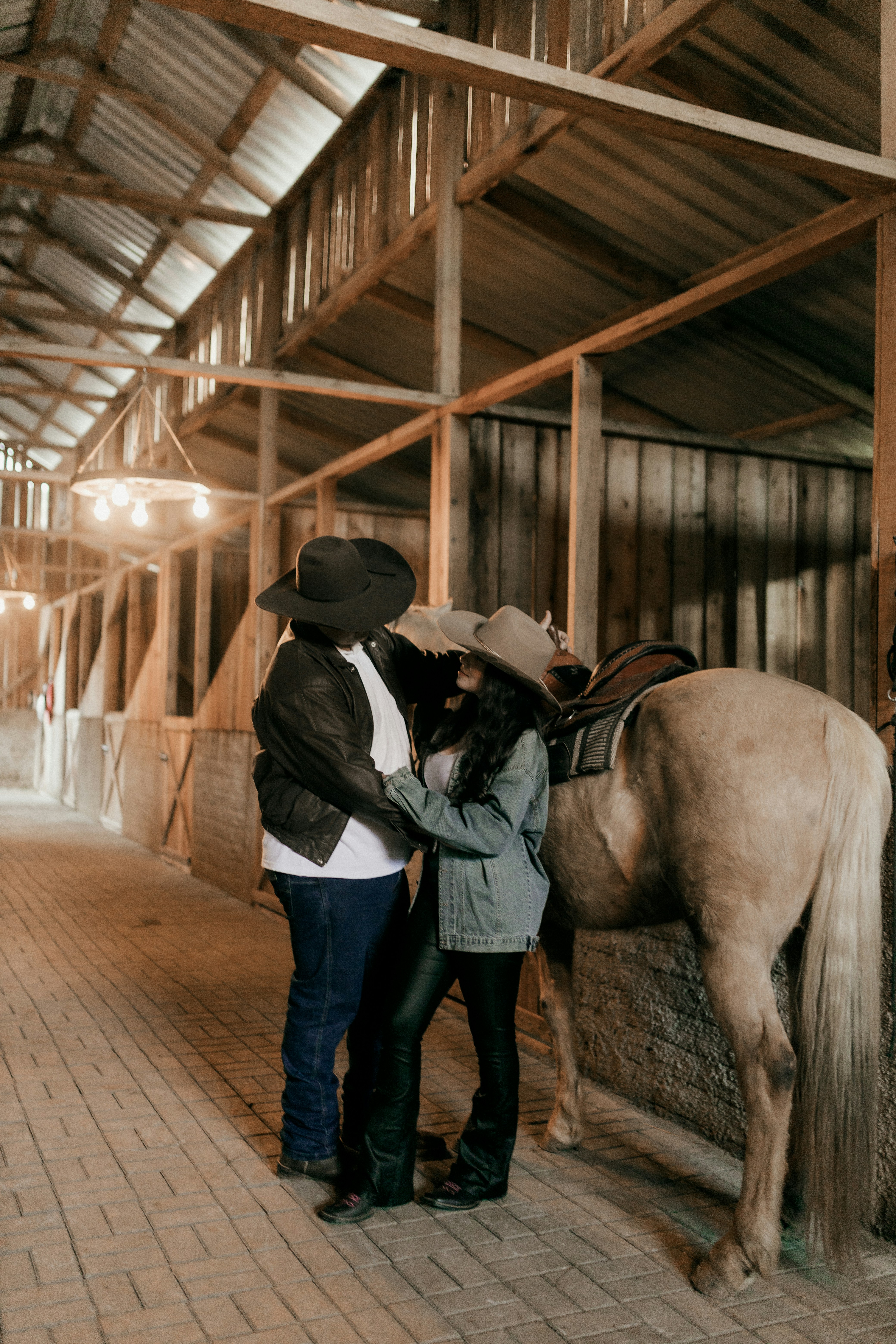 Barnside Embrace: Tender Moment by a Saddled Horse