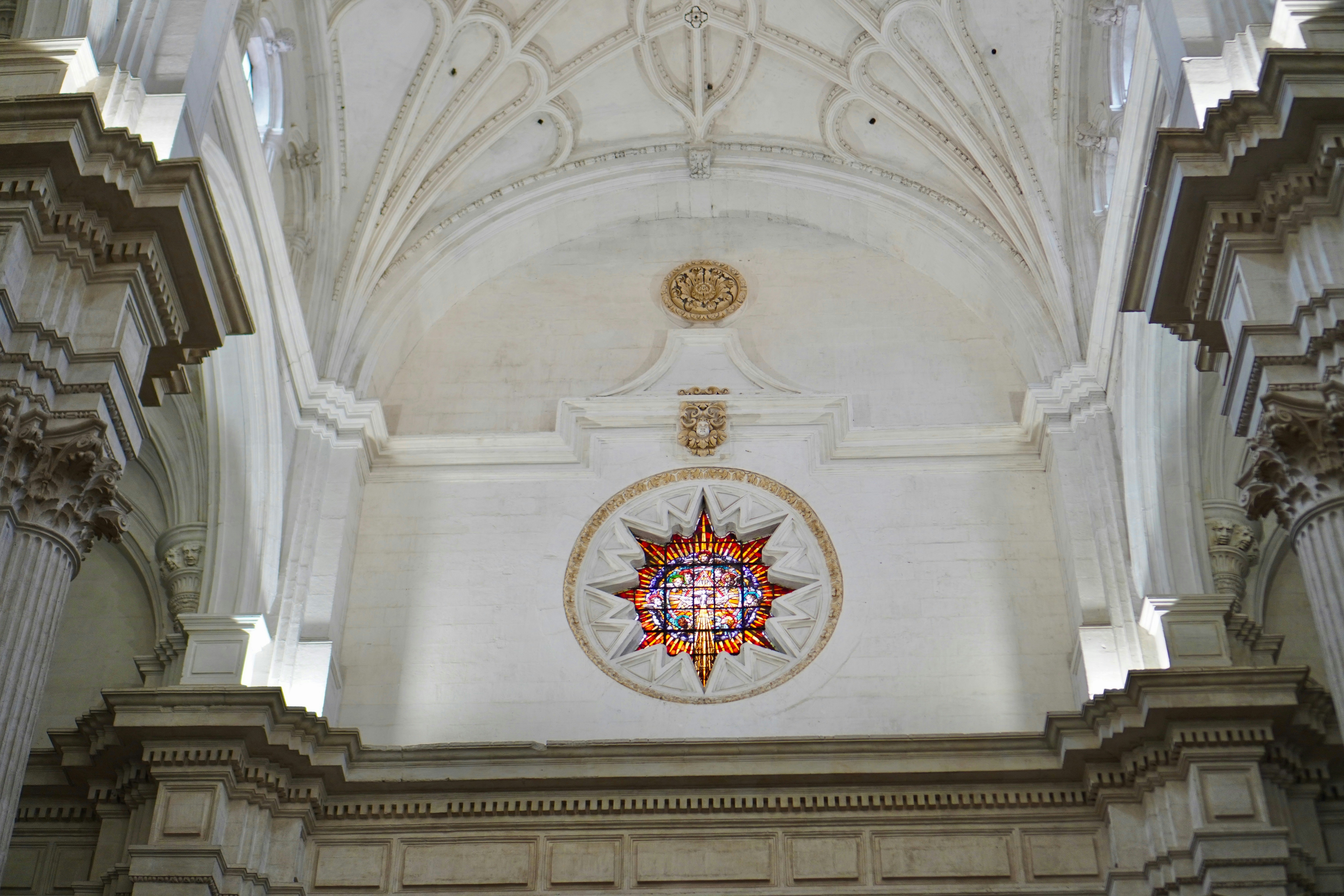 Starburst Medallion Anchoring a Cathedral's Ornate Vaults