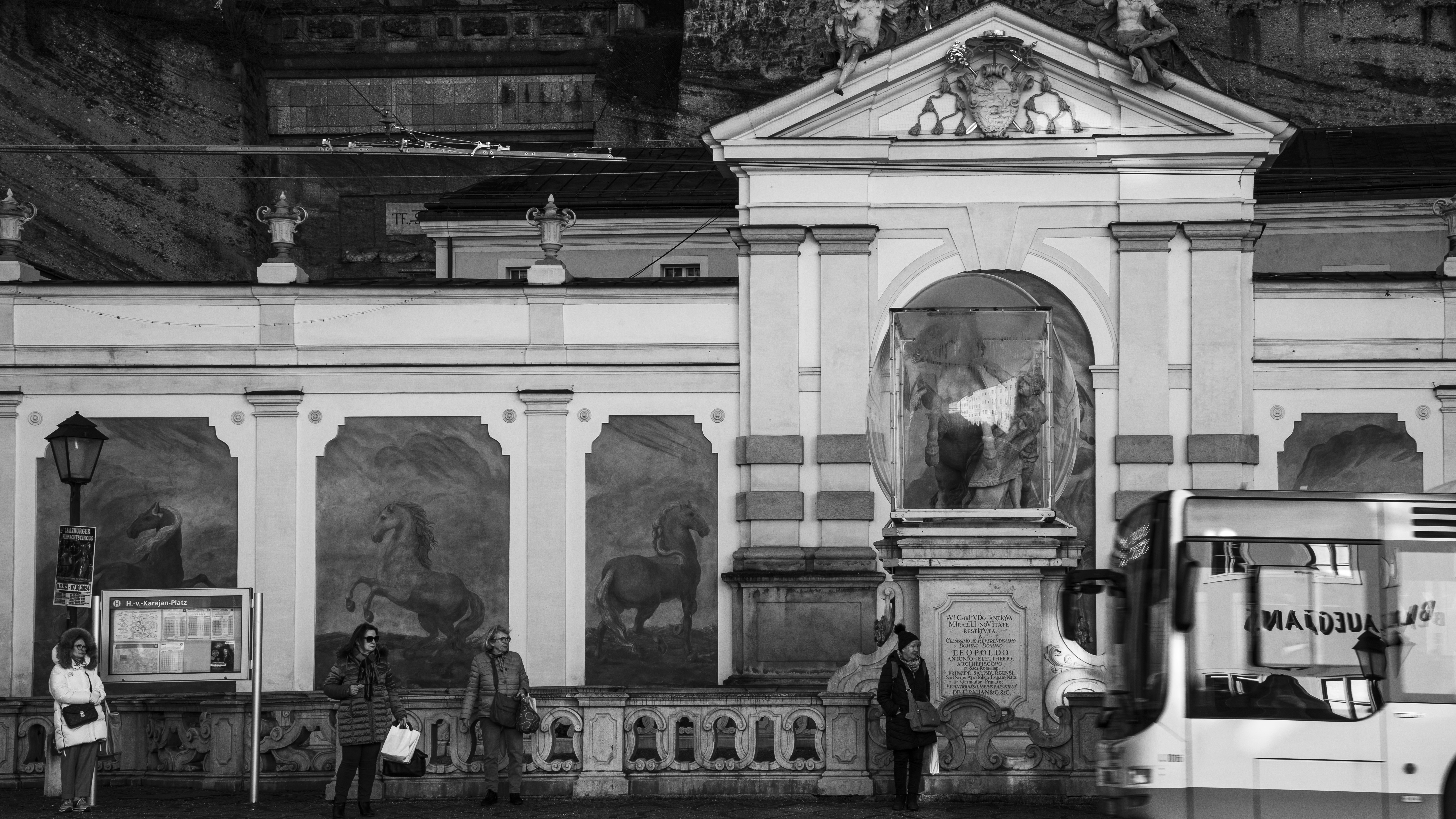 Black and white of a historic building with murals.