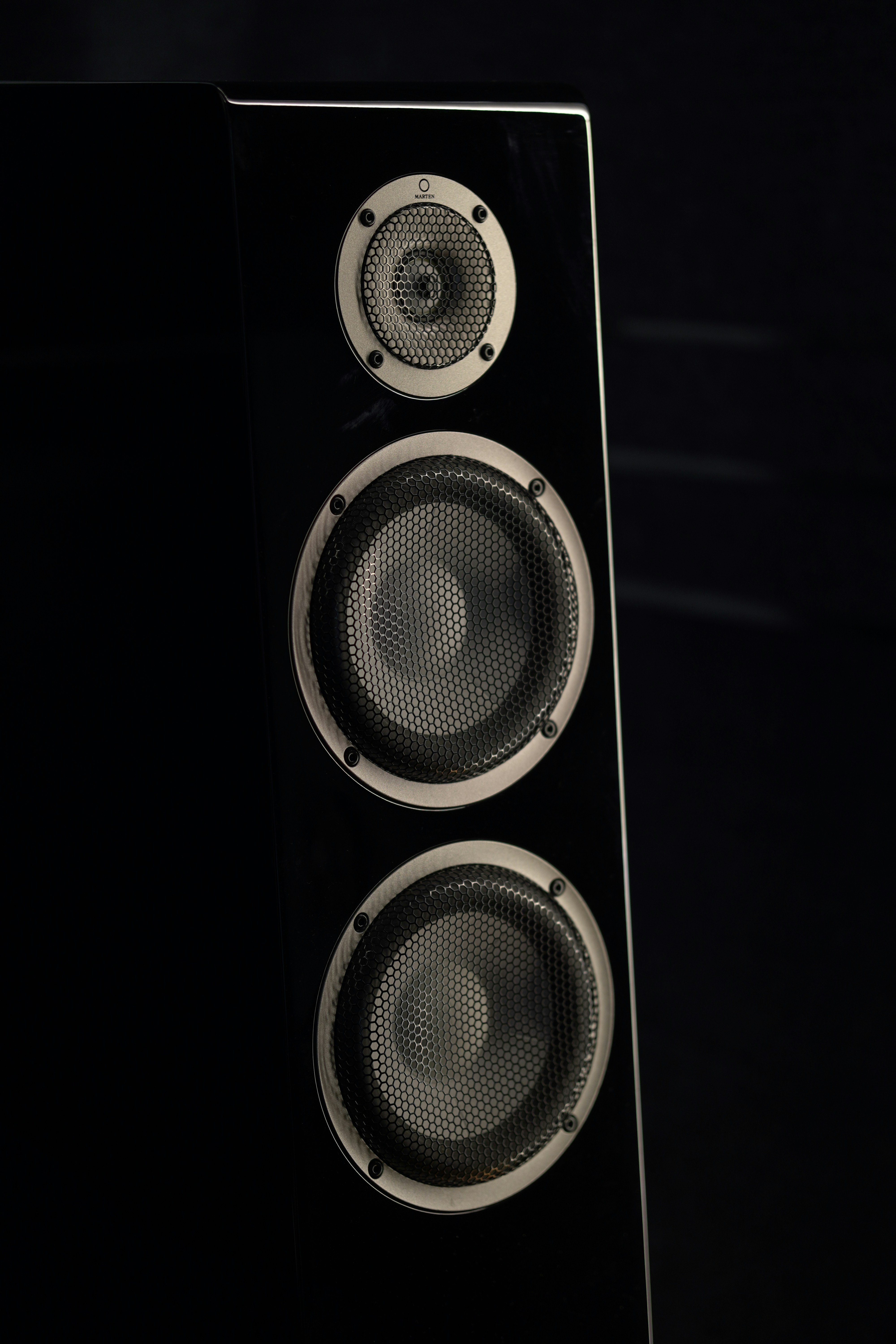 Black speaker with three drivers on-display drivers