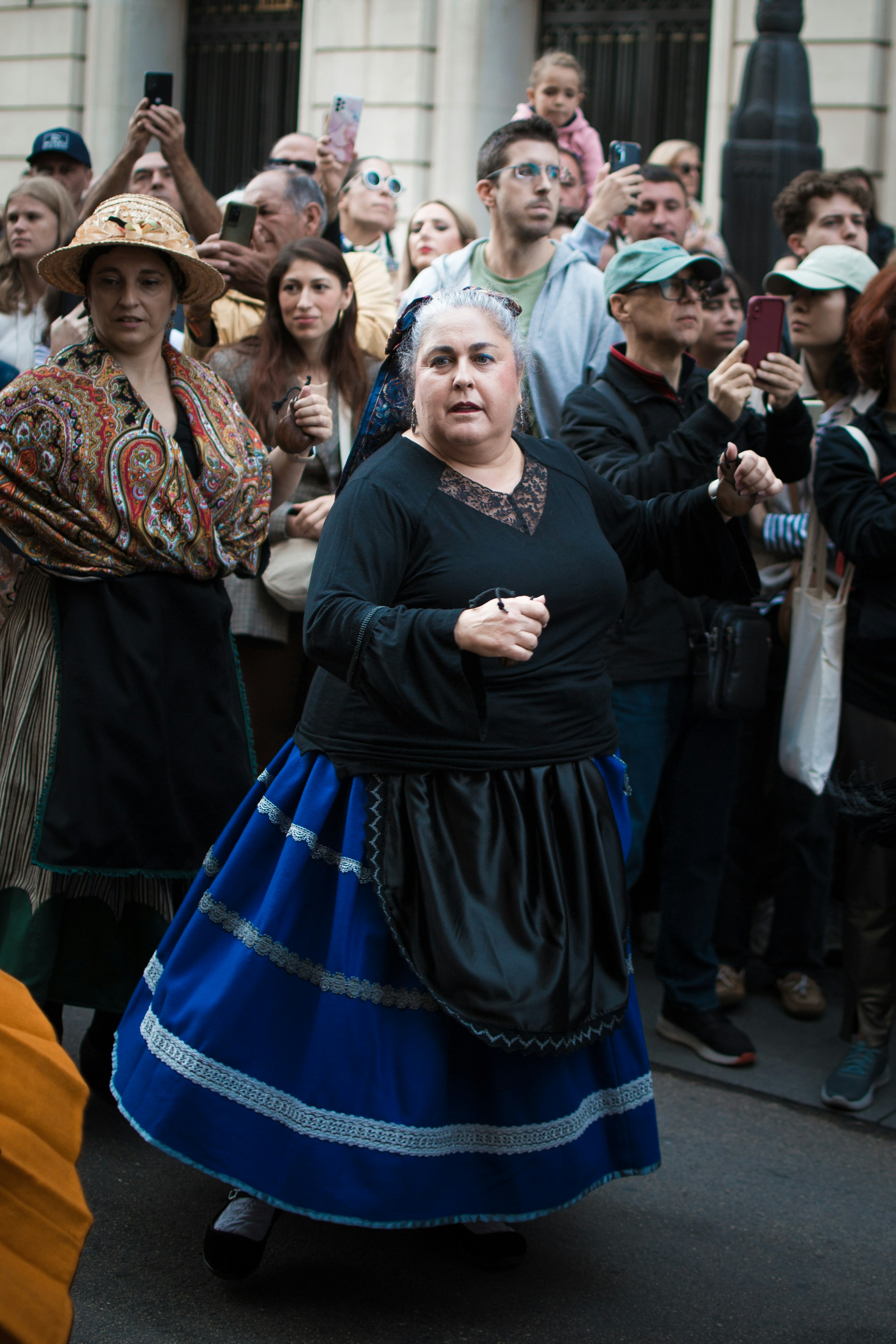 Center Stage in Indigo: A Street Ballad Unfolds Among the Crowd