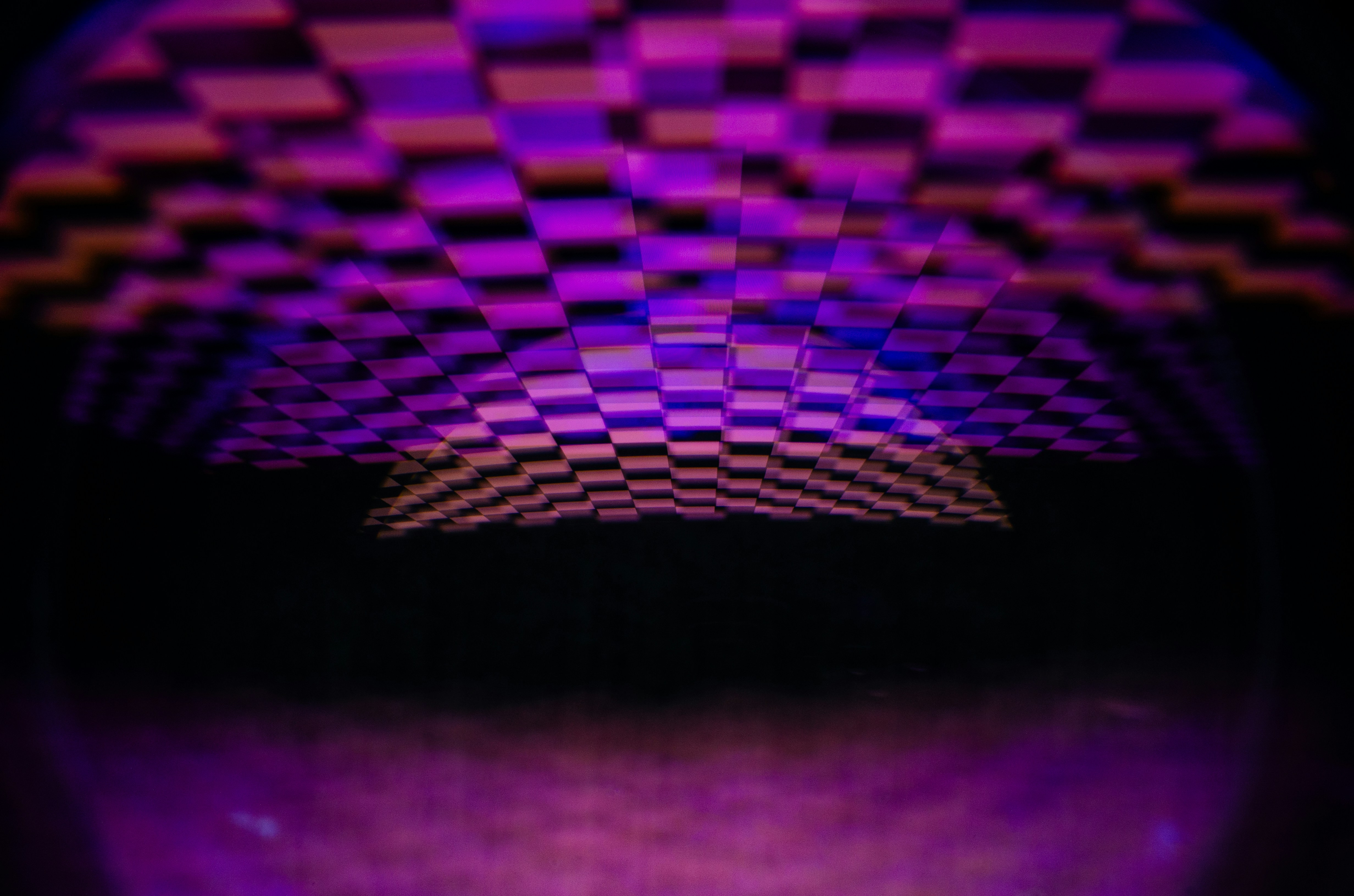 Abstract checkered pattern with purple and pink hues.