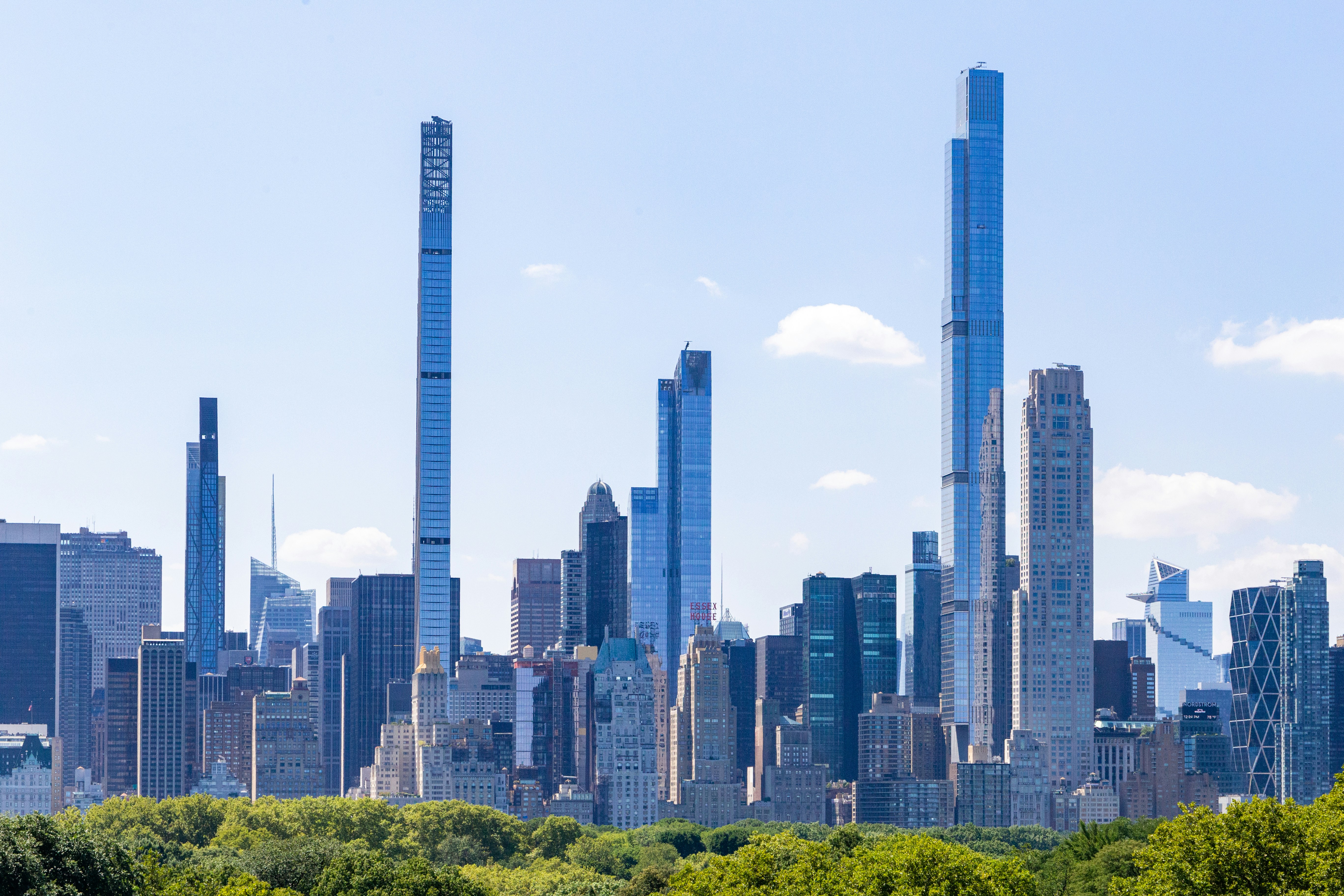 A striking skyline featuring a collection of modern skyscrapers, showcasing architectural diversity against a clear blue sky.
