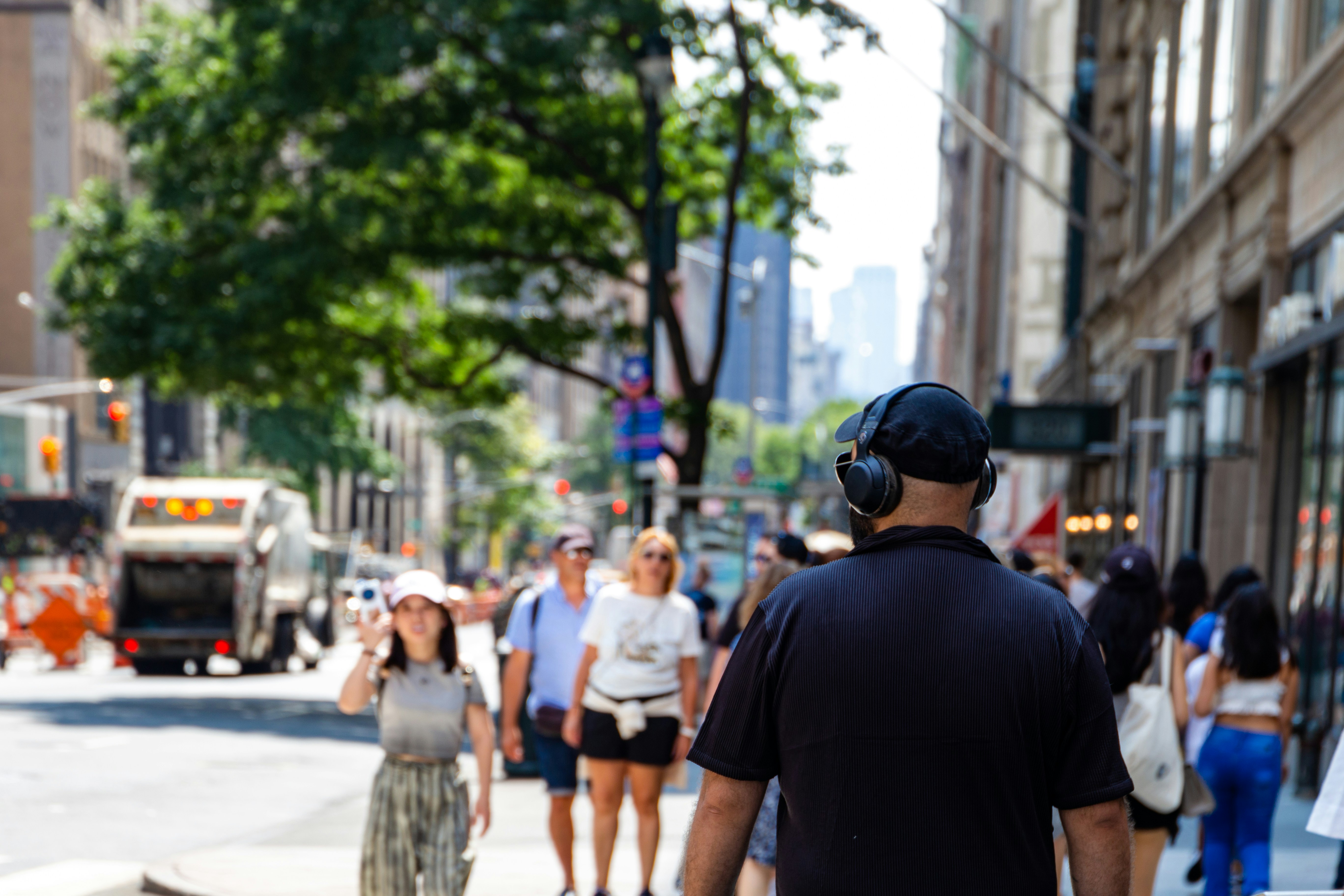 People walking on a sunny city street