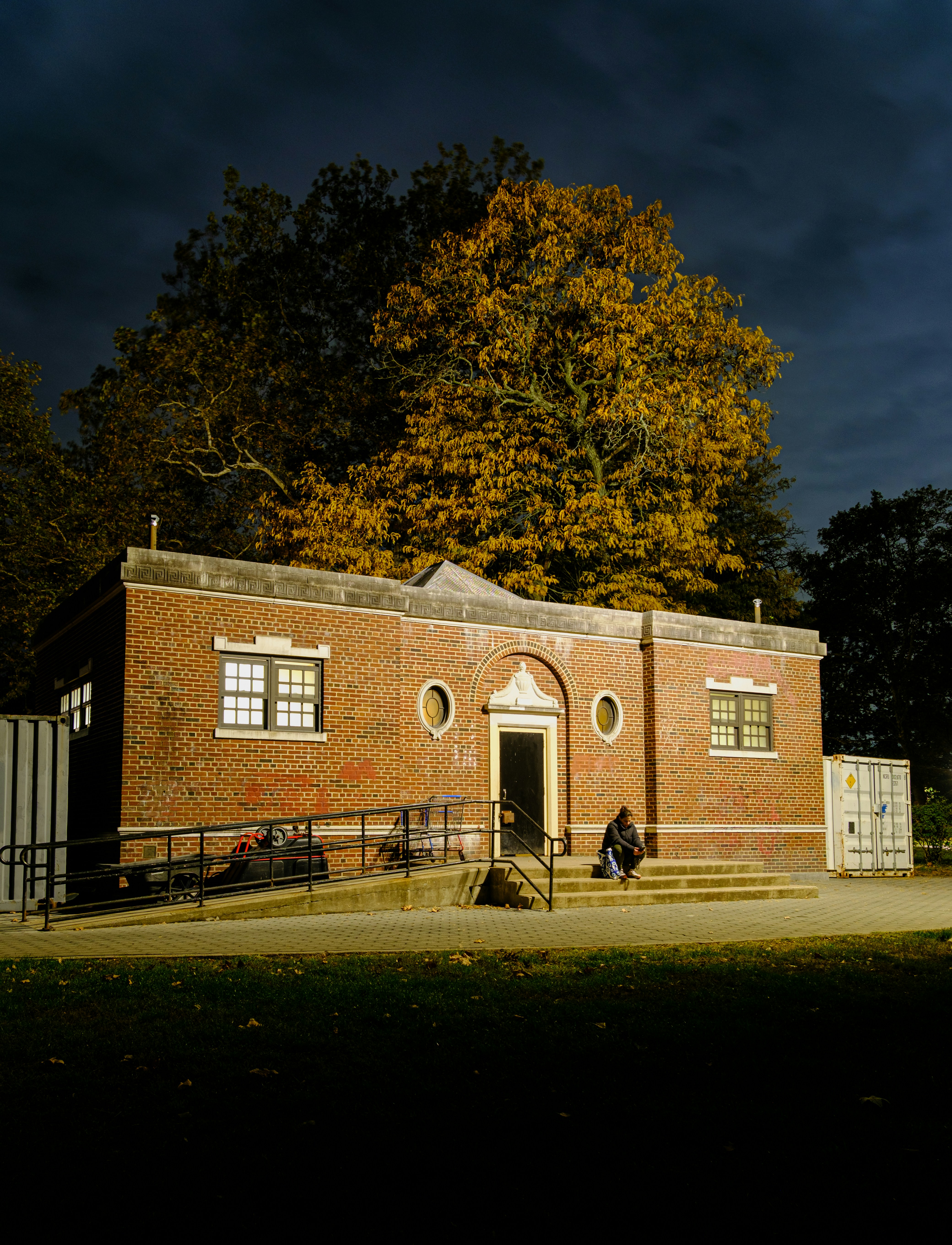 Autumn's Embrace: A Quiet Moment by the Brick Pavilion