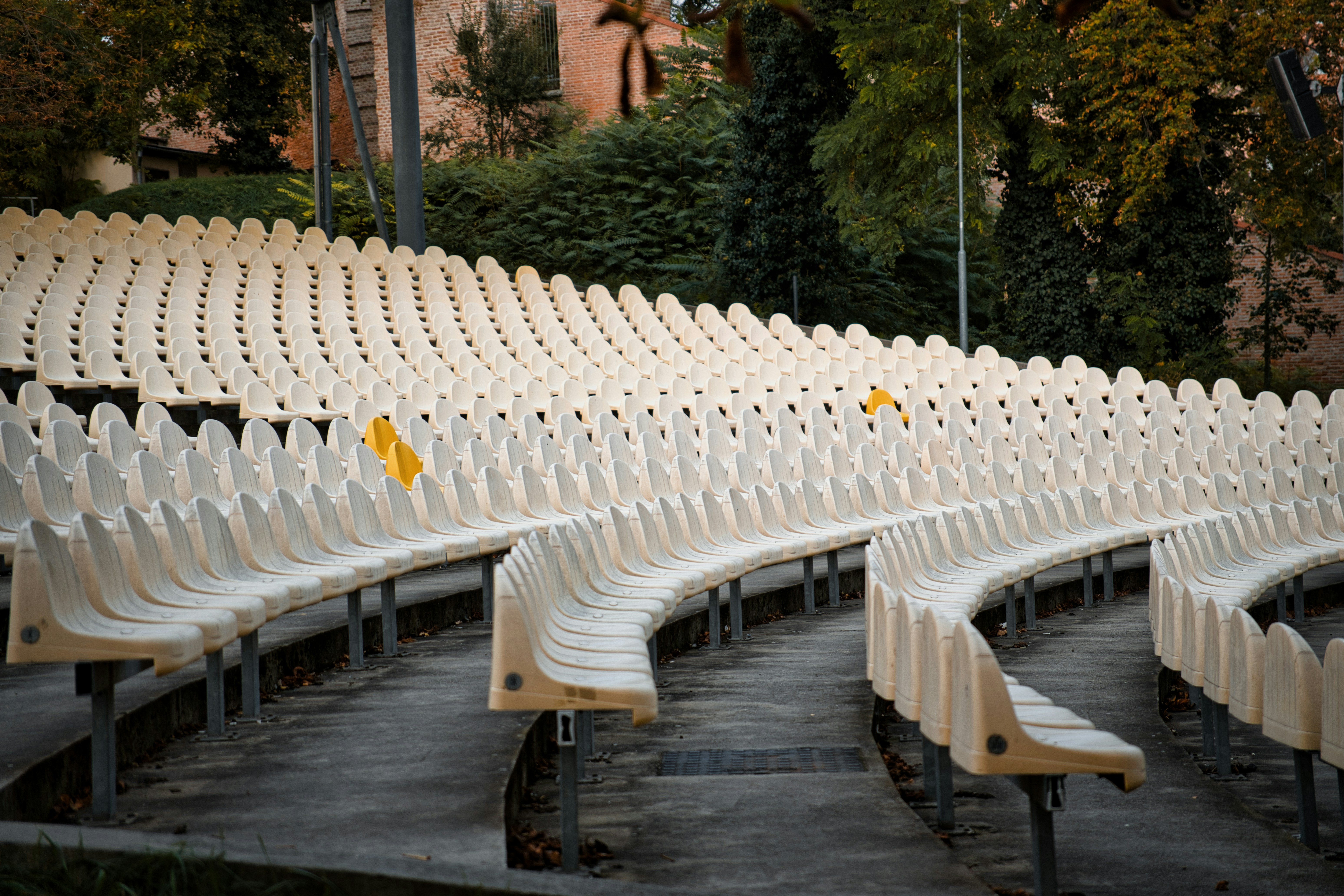 Empty outdoor amphitheater seating with trees in background