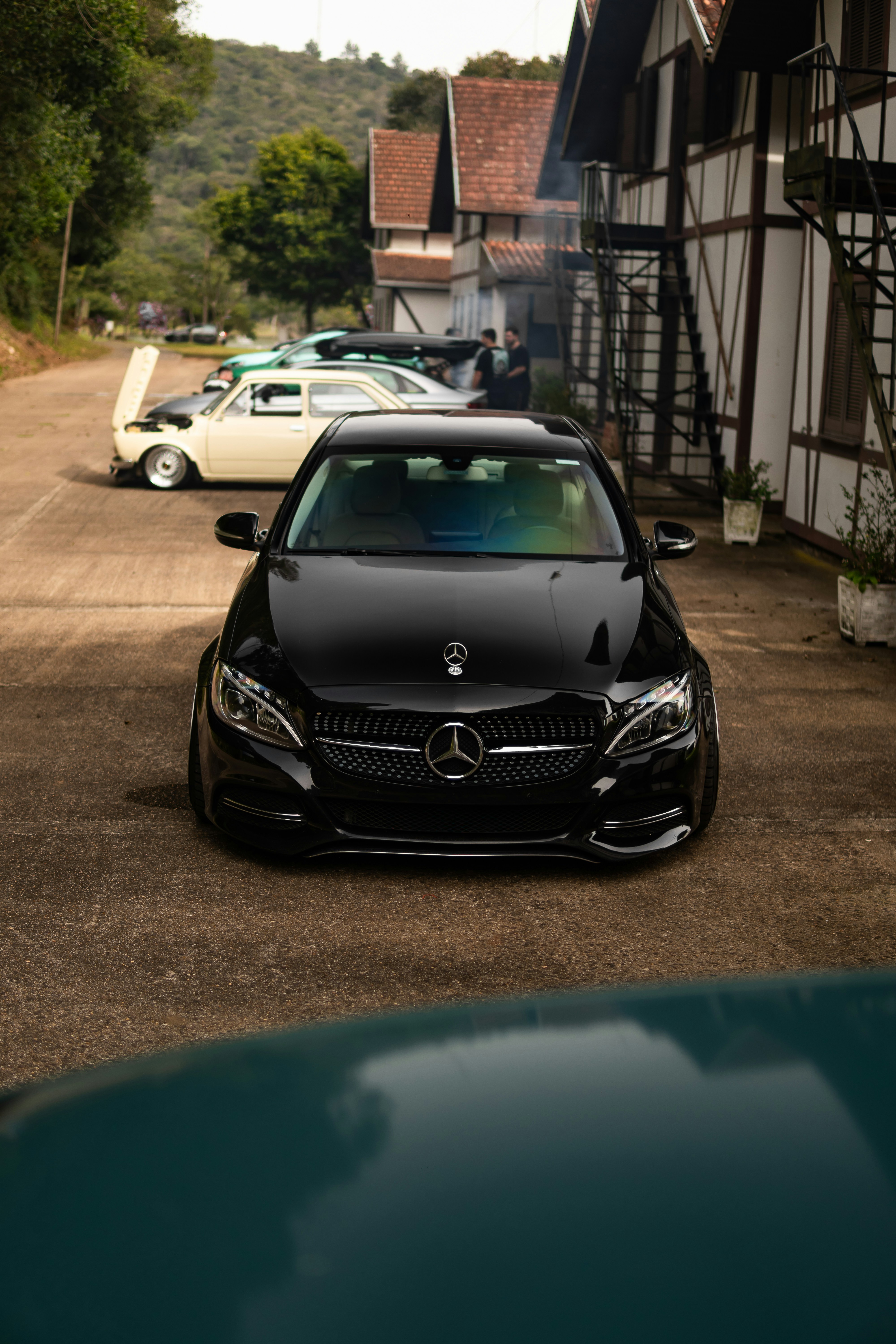 Noir Mercedes at Center Stage in a Quiet Car Yard