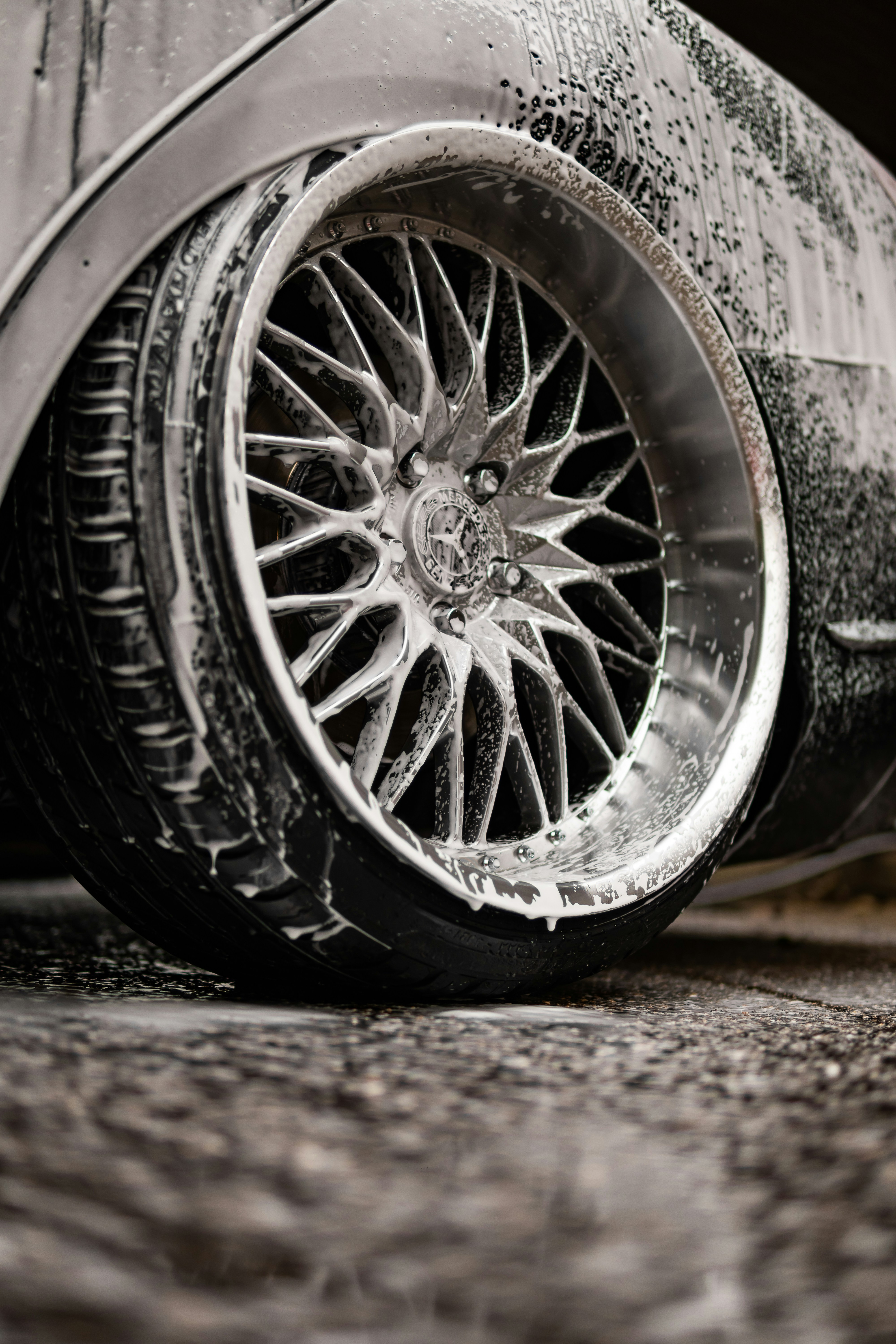 Close up of a car wheel covered in soap