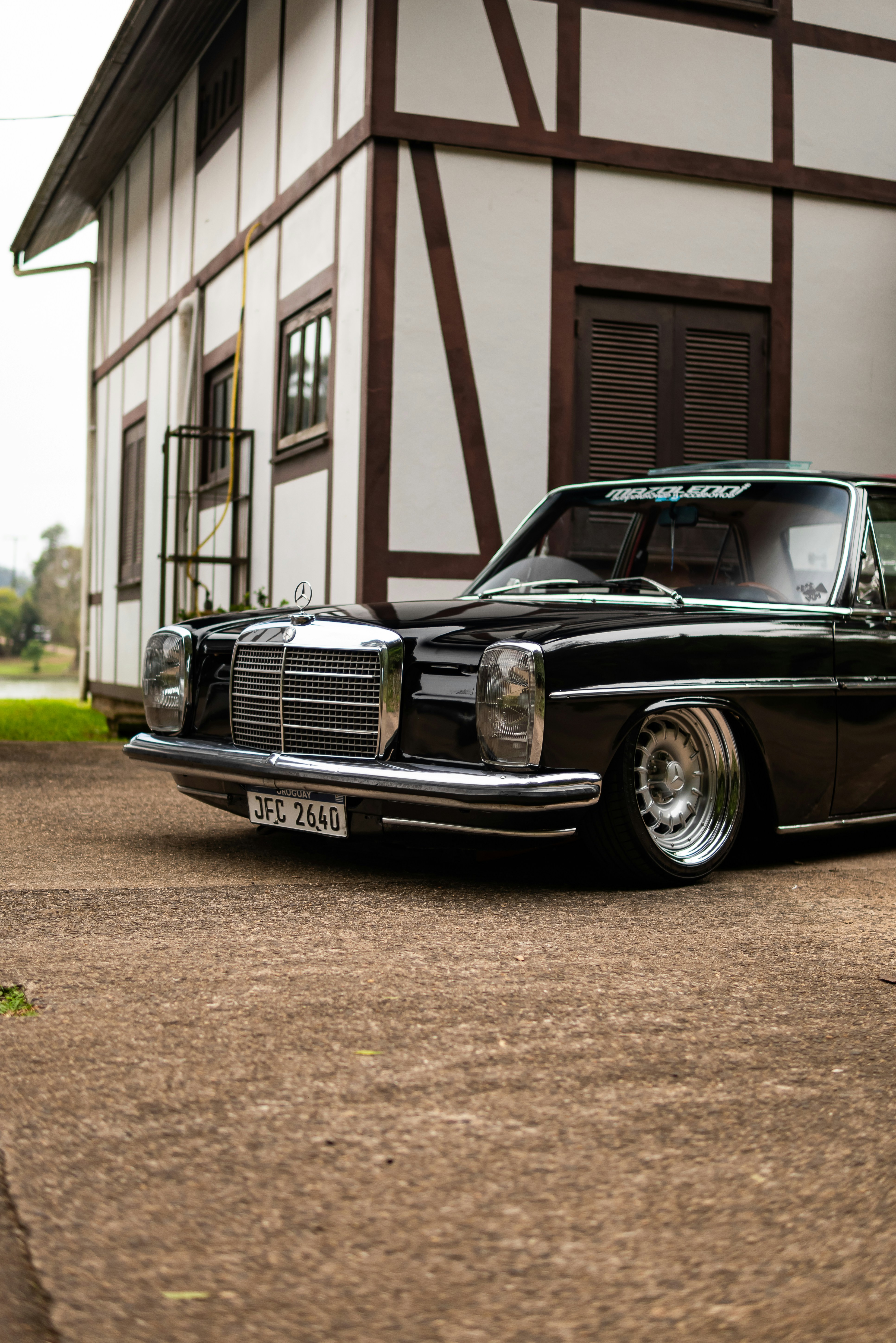 Foto Sebuah mercedes-benz hitam klasik diparkir di luar sebuah gedung ...