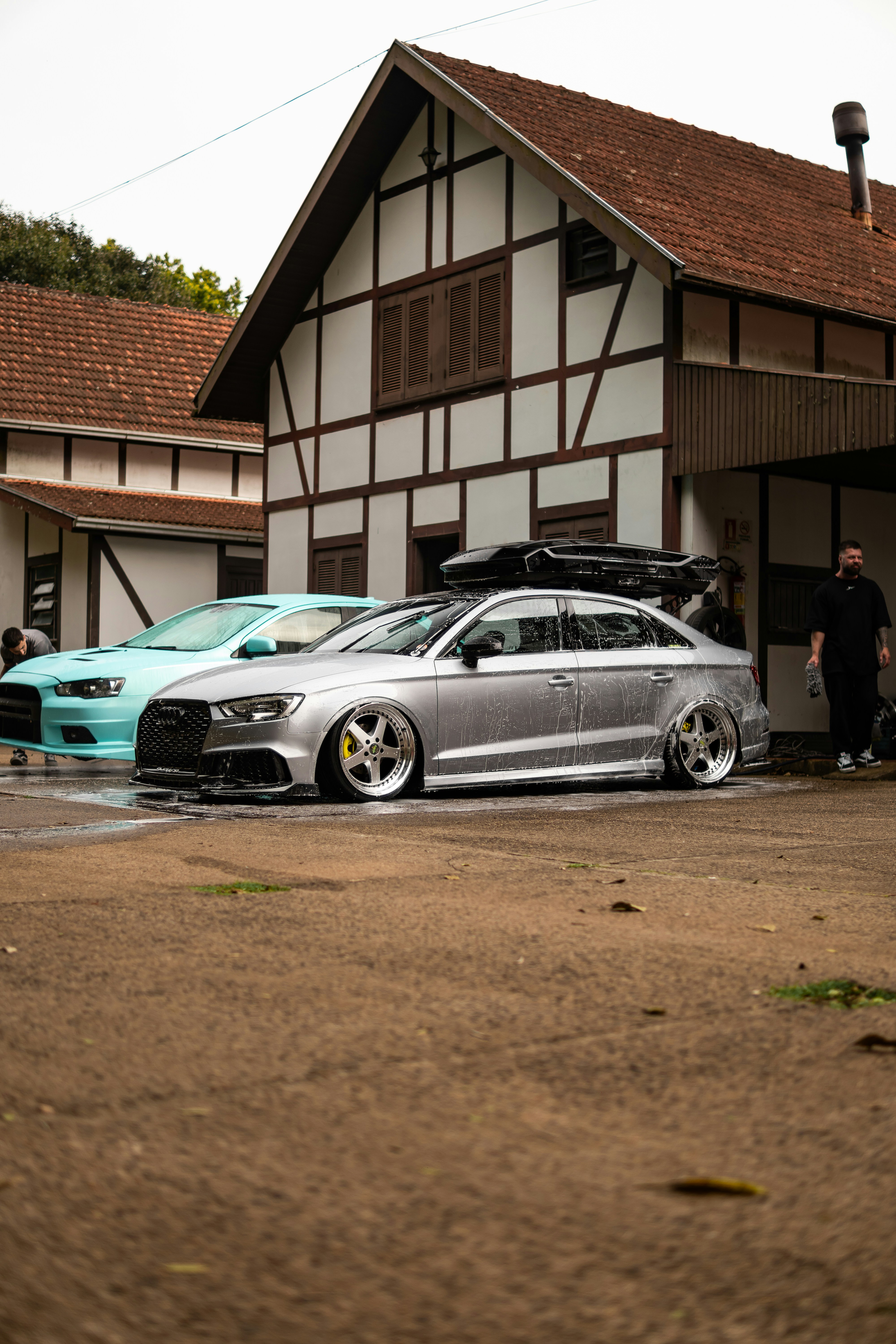 Low-Slung Silver Wagon Anchors a Tudor-Style Street Scene