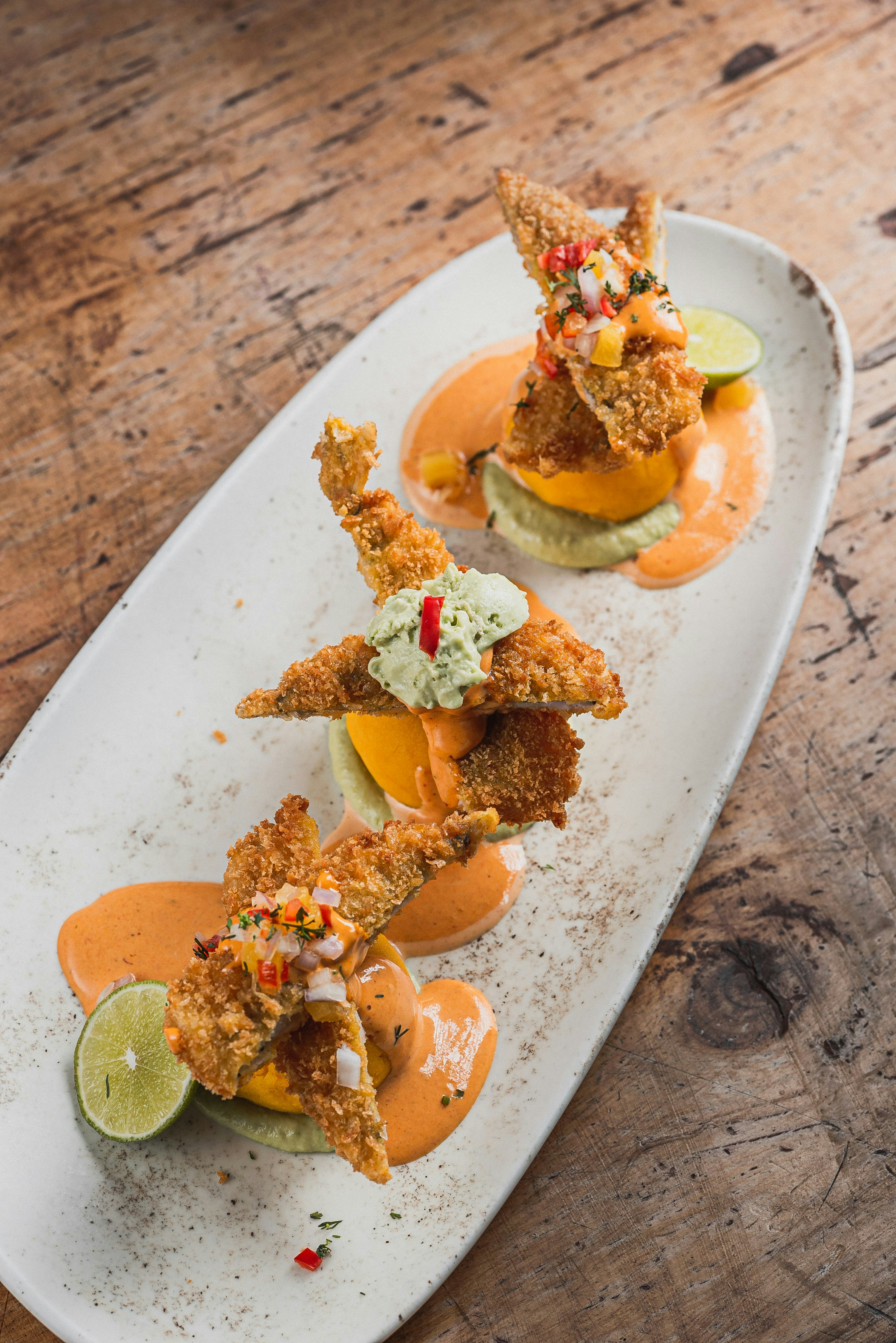 Crispy fish appetizers with mango salsa and avocado puree. photo – Free ...