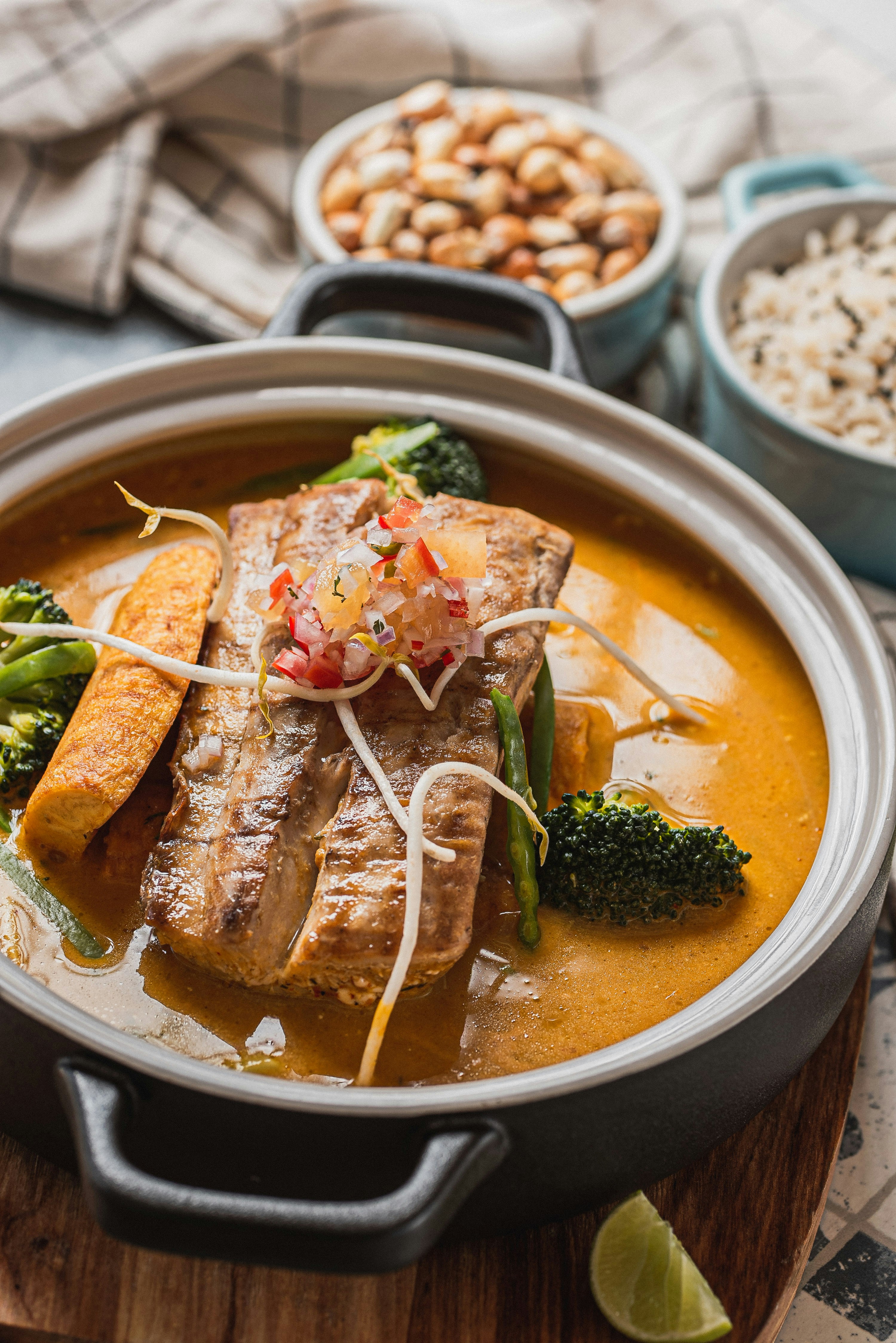 Pork belly with vegetables in a rich orange sauce.