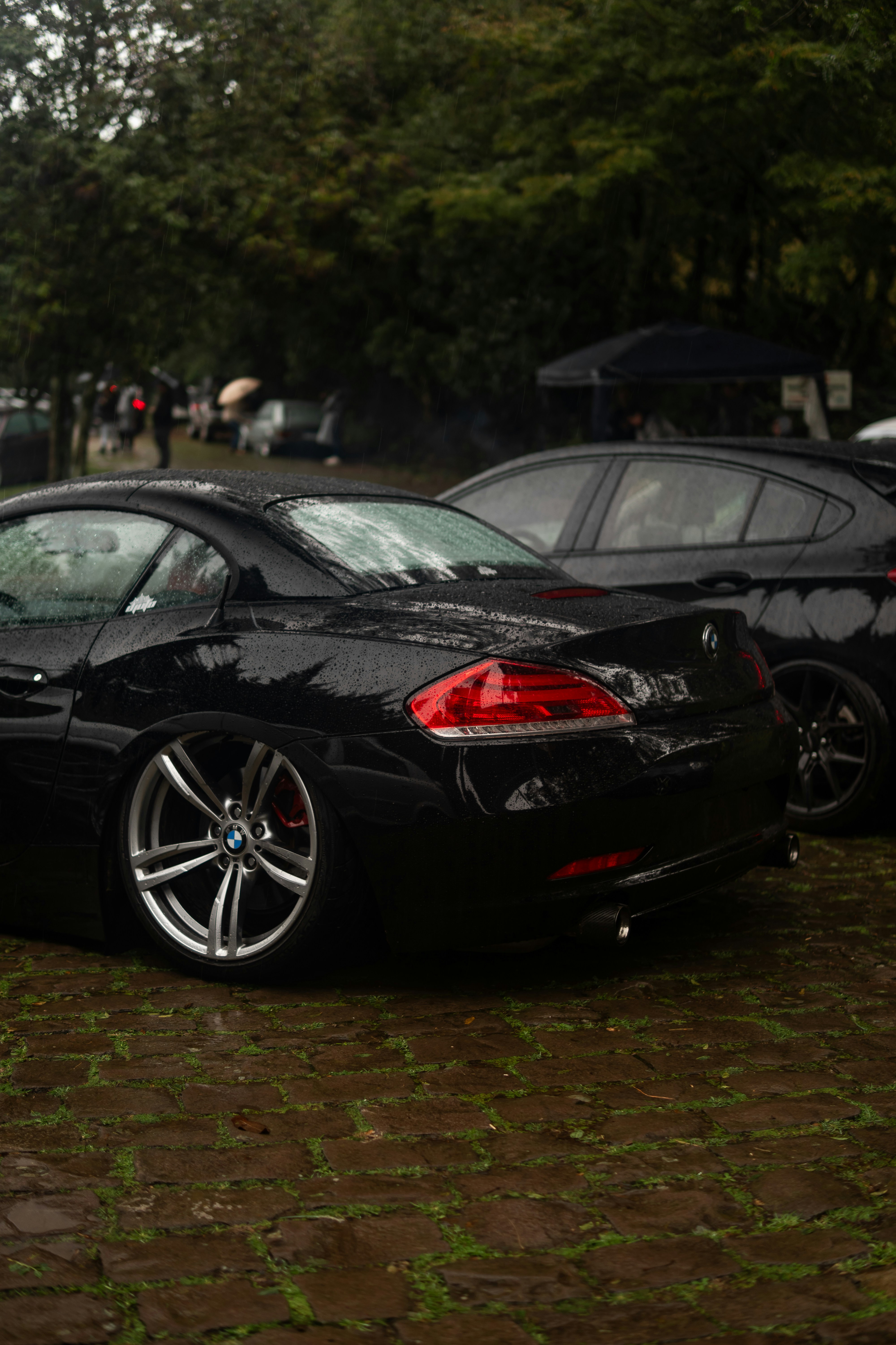 Rain-Washed Chrome: BMW's rear-wheel glow in a dim parking lot