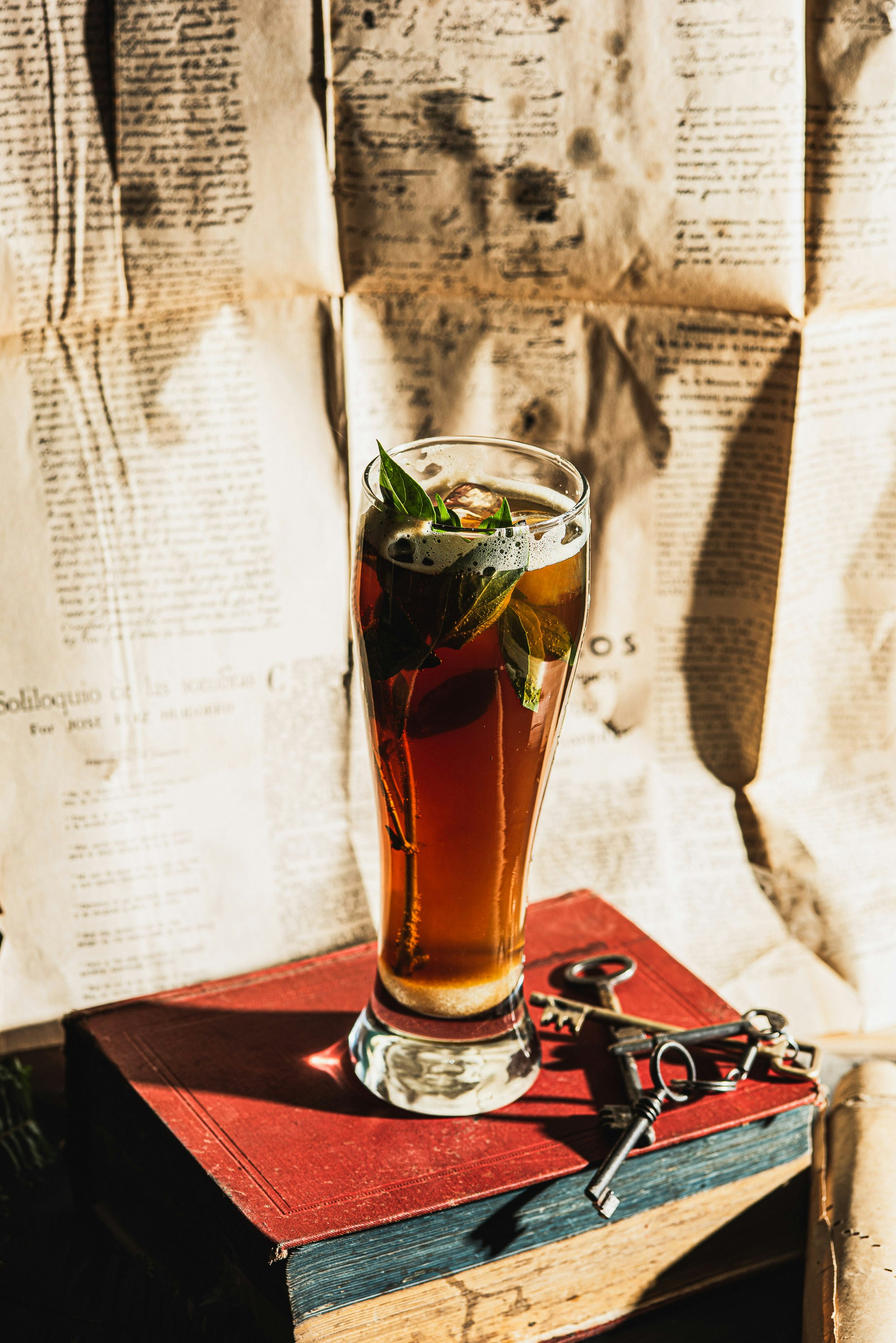 Tall glass of iced tea with mint on books