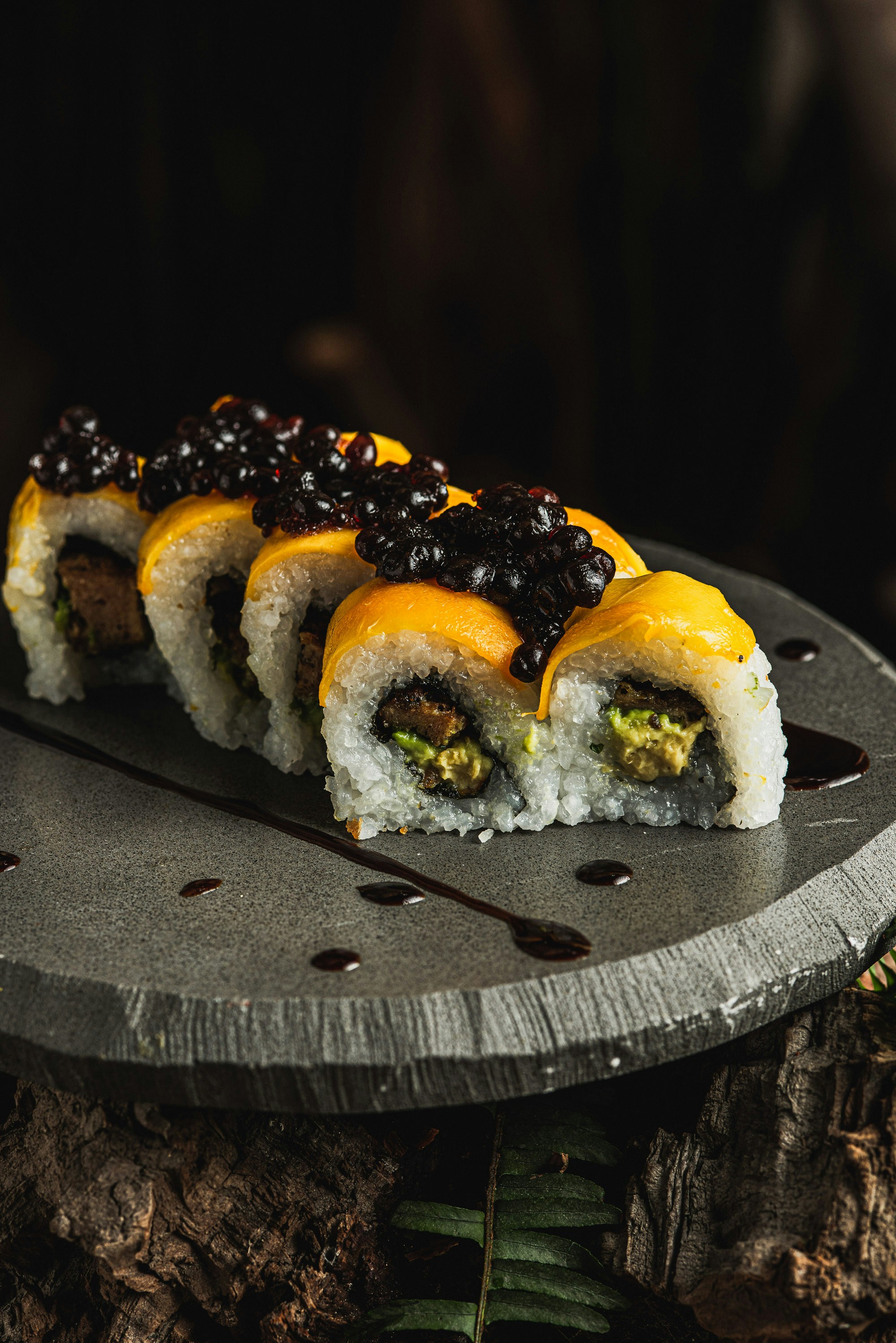 Pearls on Stone: Citrus-Topped Nigiri Rolls Adorned with Black Caviar