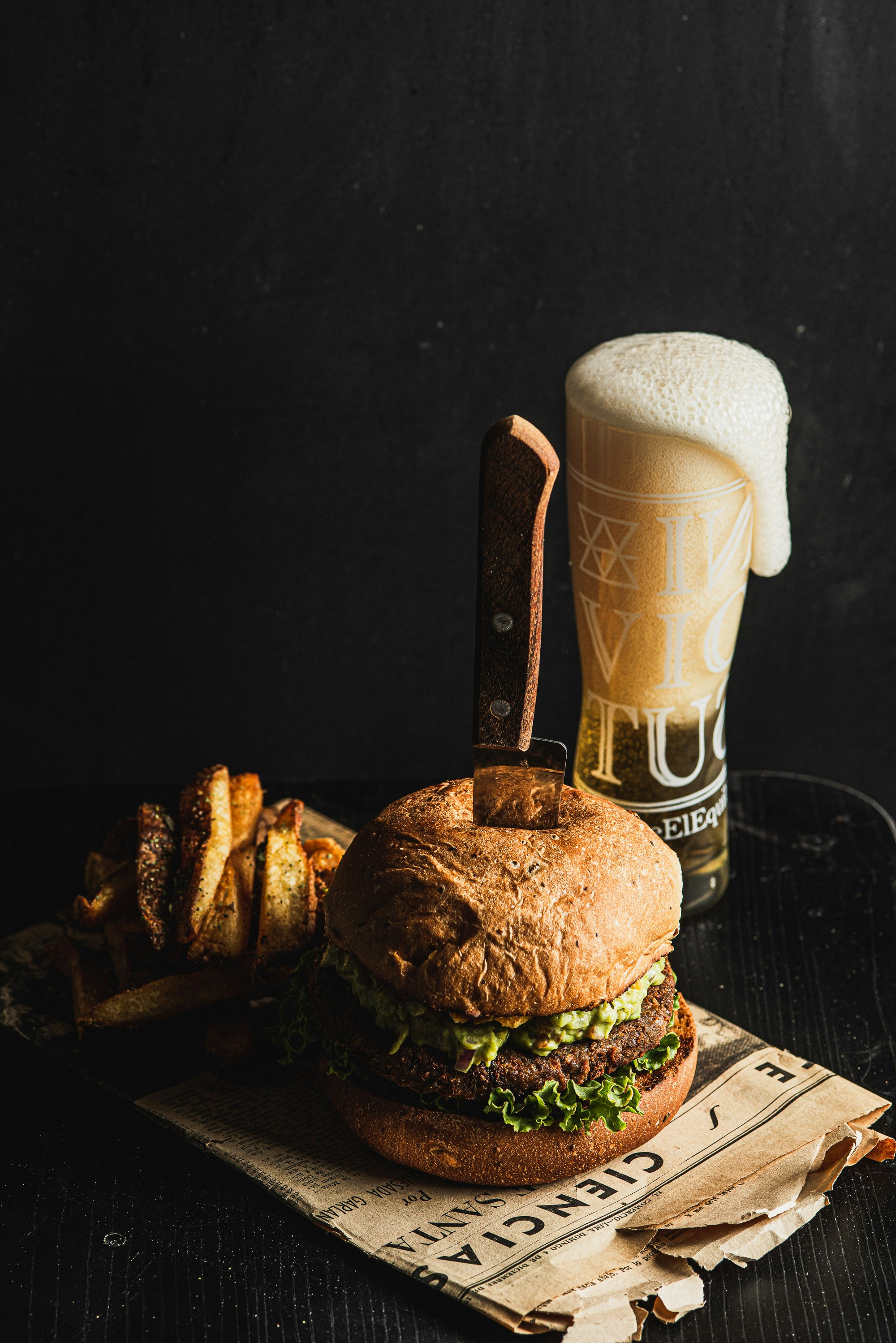 Midnight Burger Ritual: A Knife Impales the Patty Under Foamy Glow