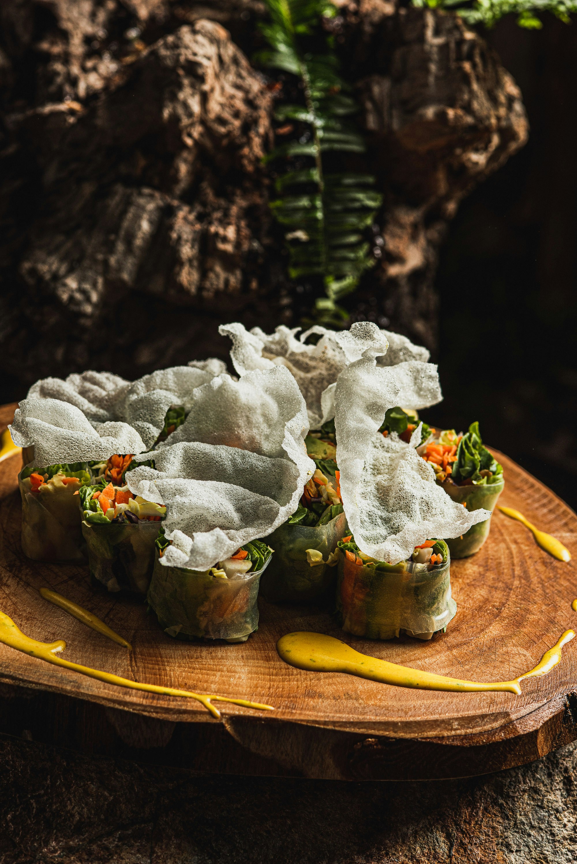 Veggie Rolls Crowned with Crisps on a Rustic Wooden Board