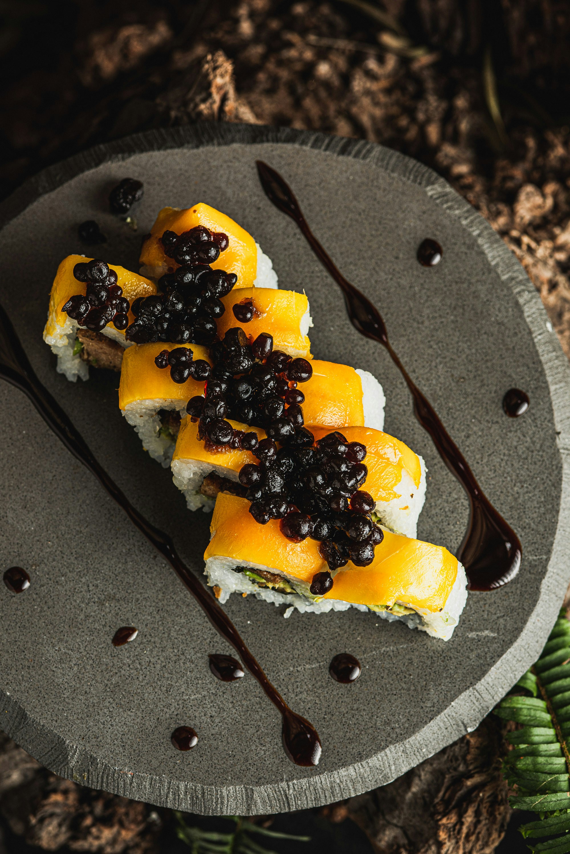 Mango-Topped Nigiri on Slate: A Diagonal Bite of Contrast