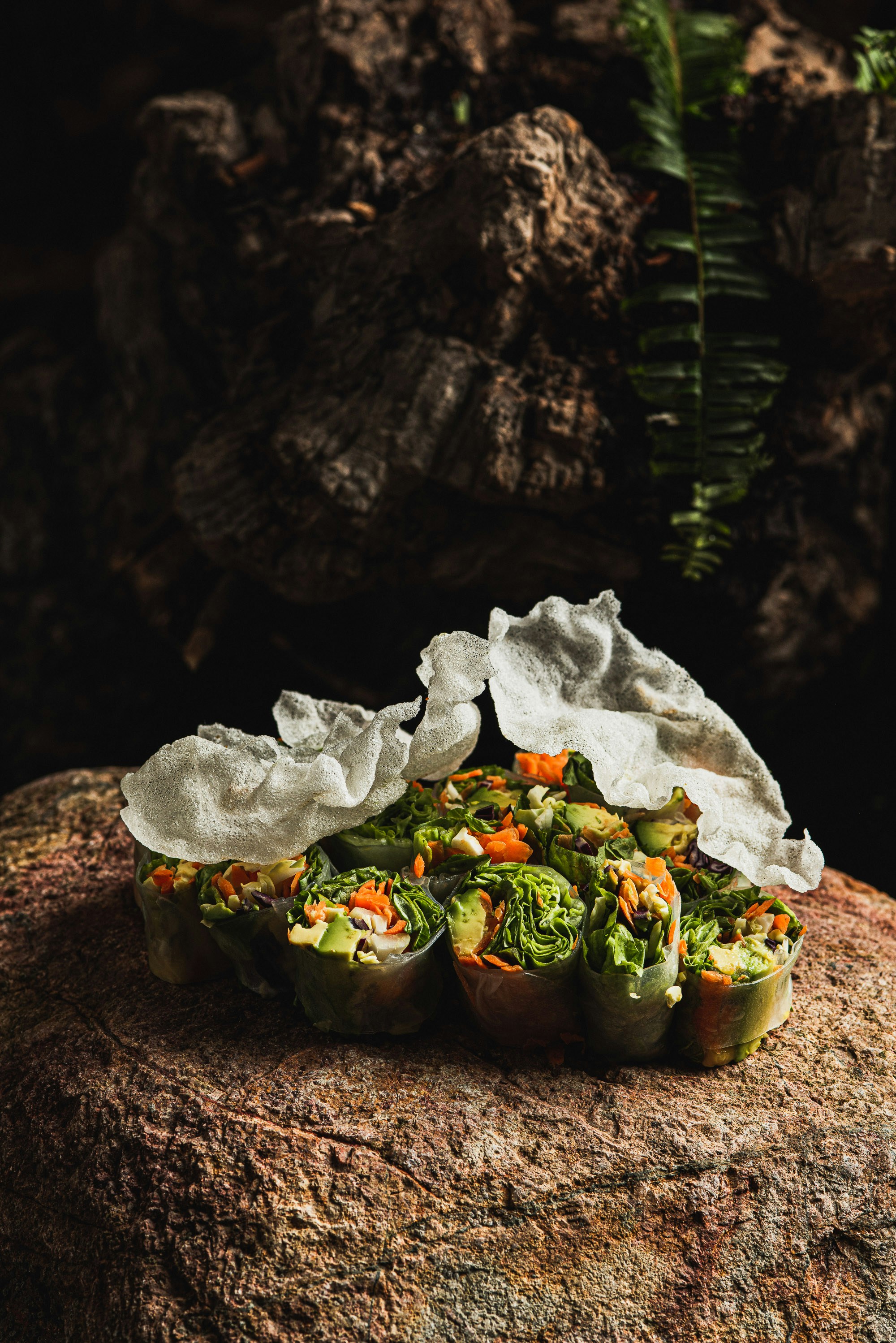 Stone Stage Veggie Spring Rolls: A Rustic Still Life on Weathered Rock