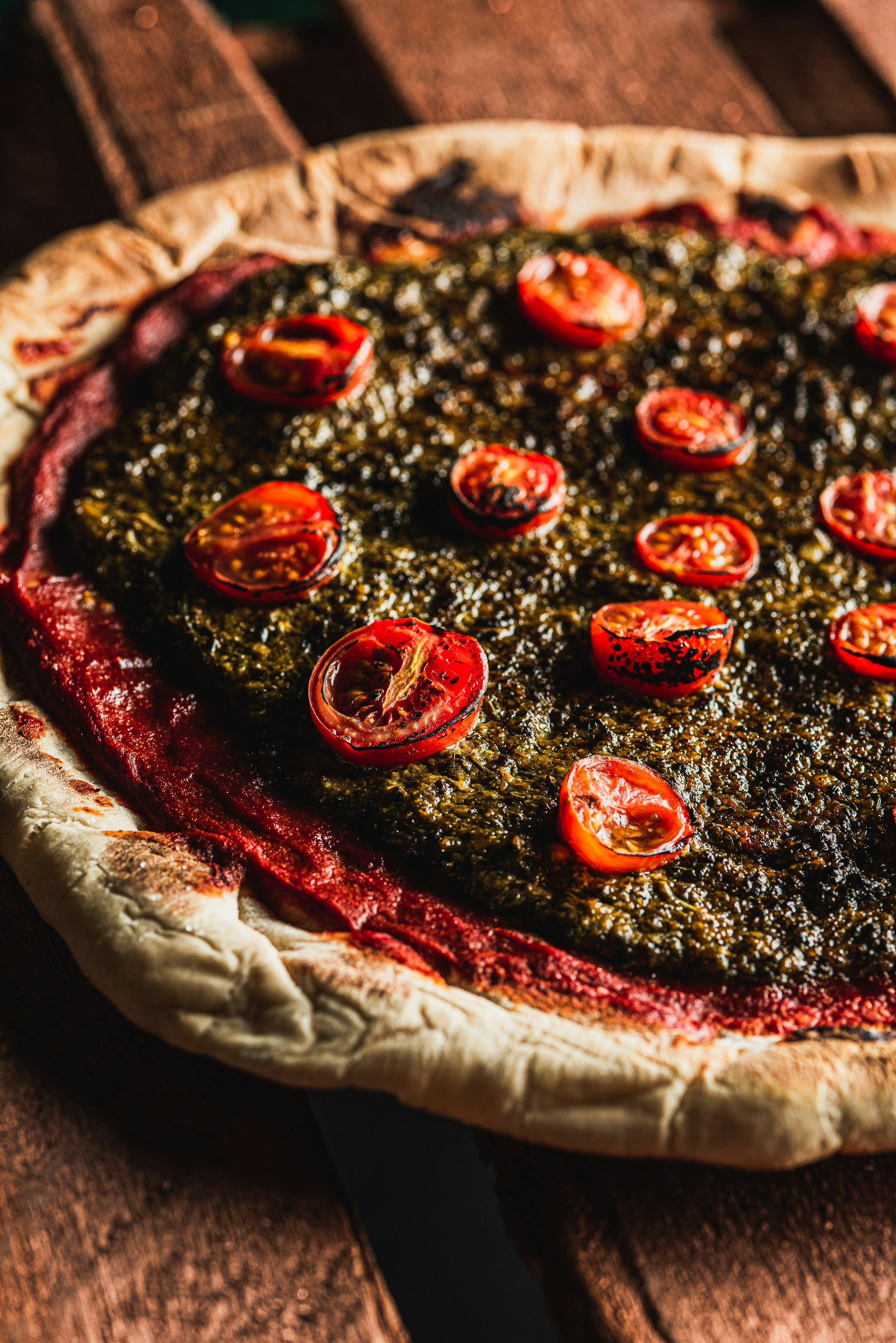 Red on Black: Cherry Tomatoes Crown a Charred Basil Crust Pizza