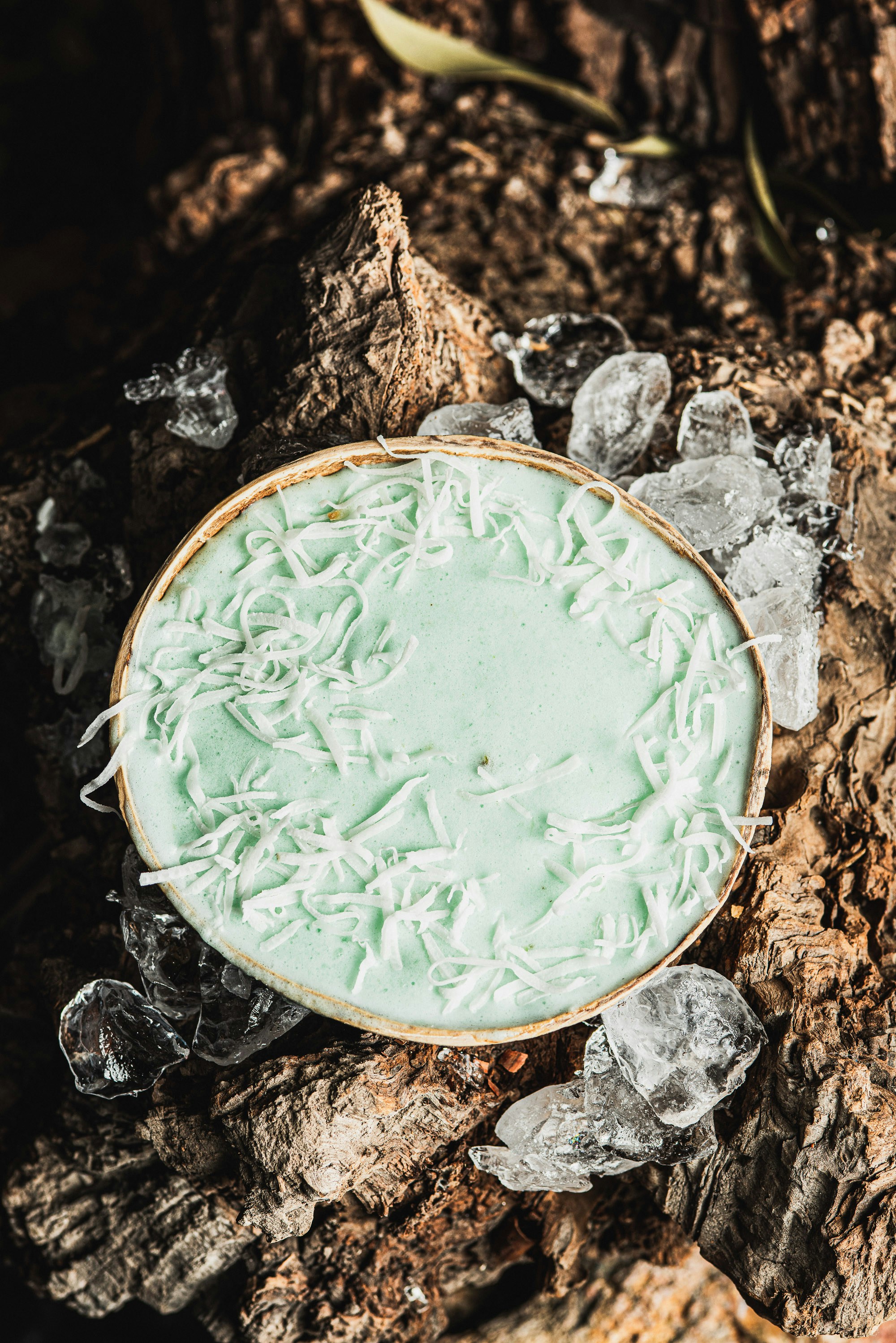 A pale green dessert topped with shredded coconut