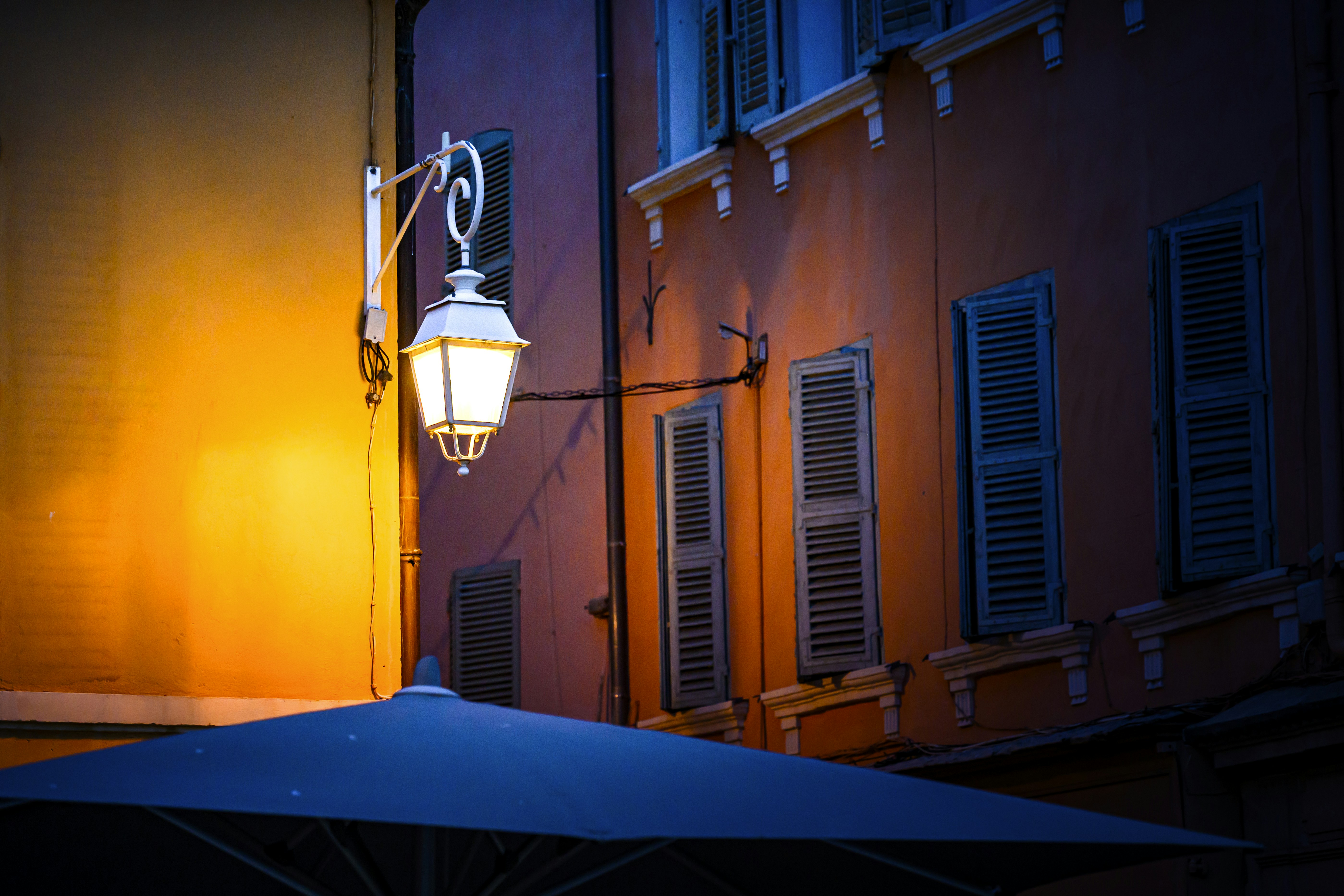 Lantern Glow on an Ochre Facade Against Indigo Night