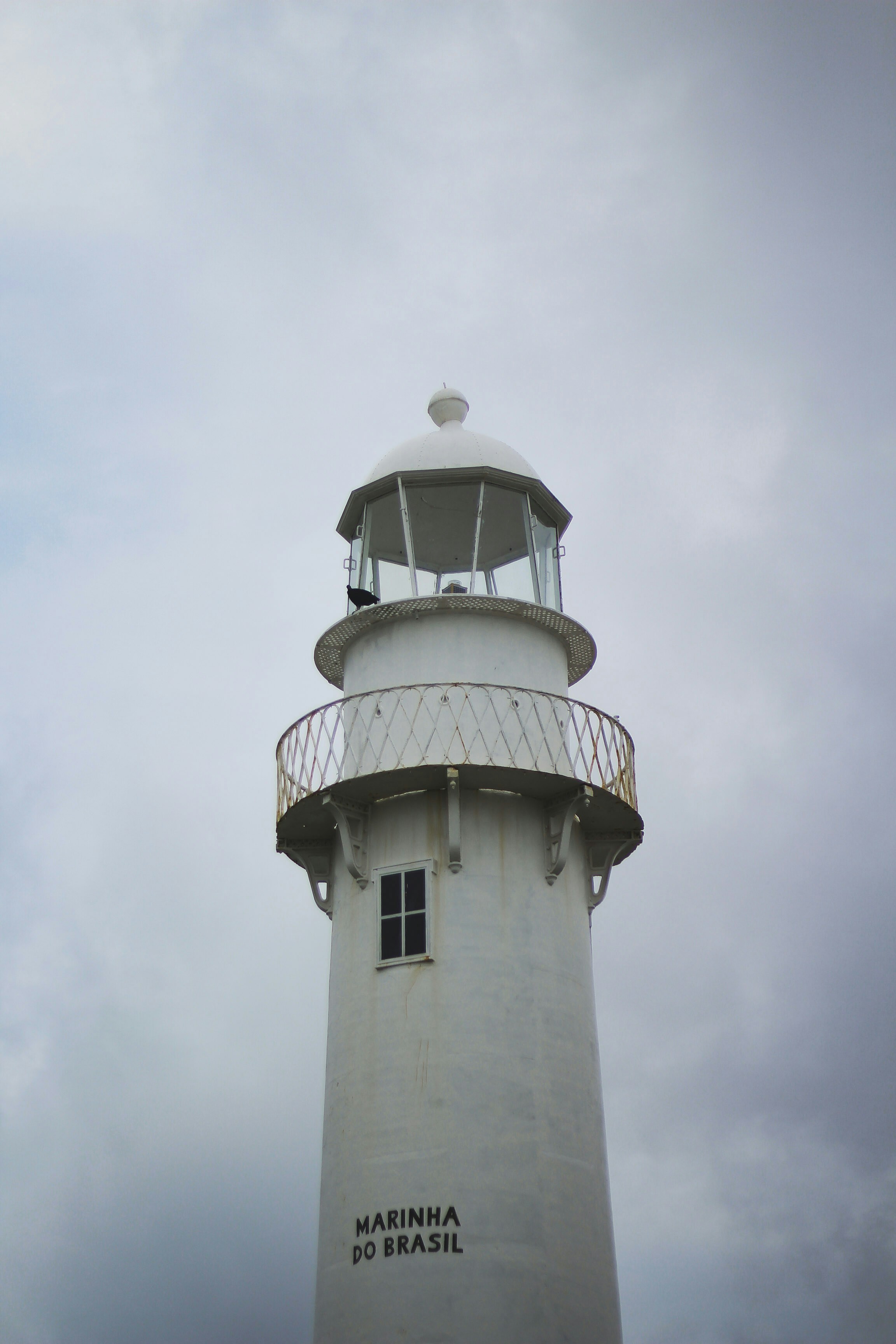 White lighthouse with 'marinha do brasil' text.