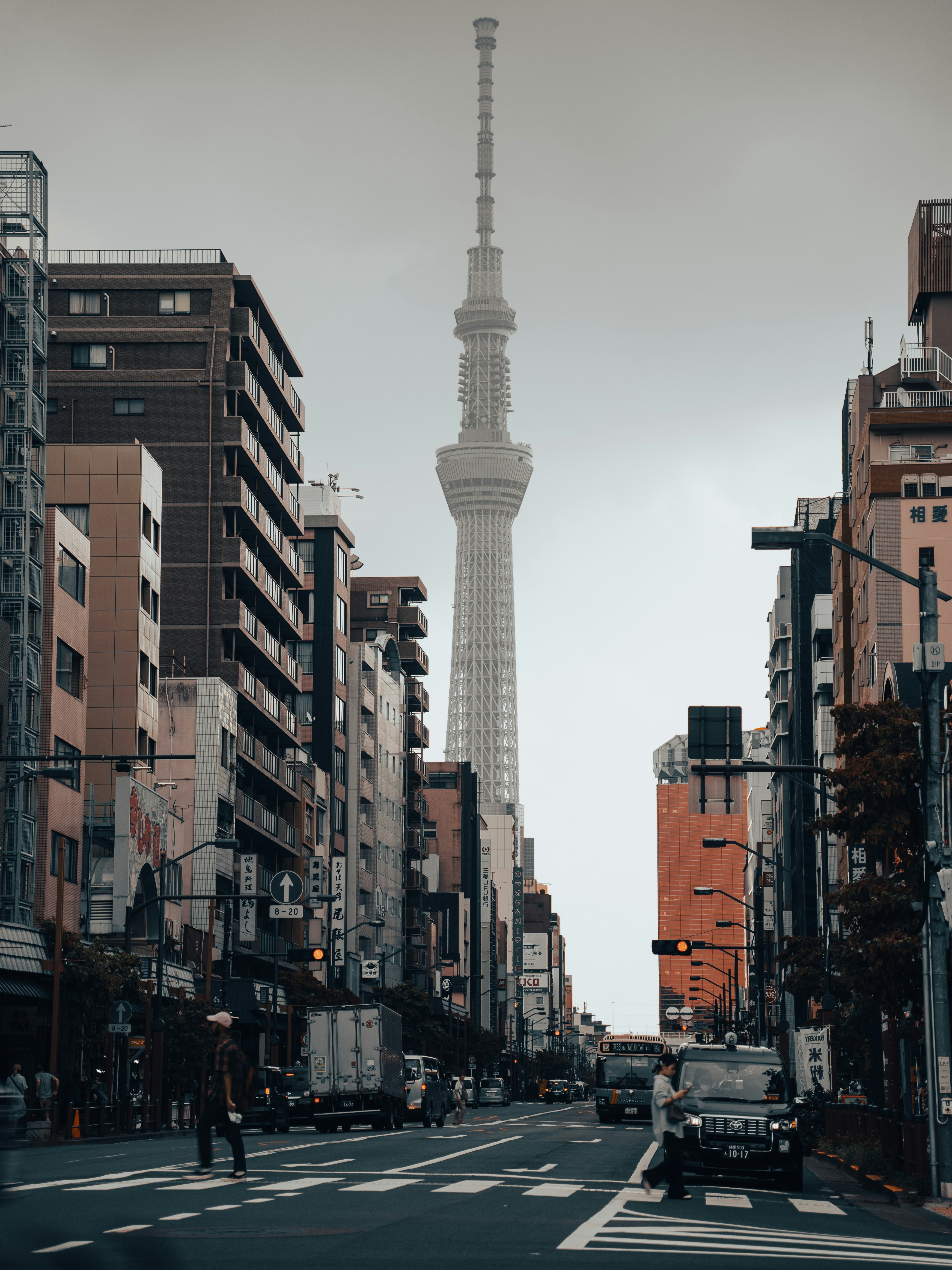 Tall skyscraper dominates a city street view