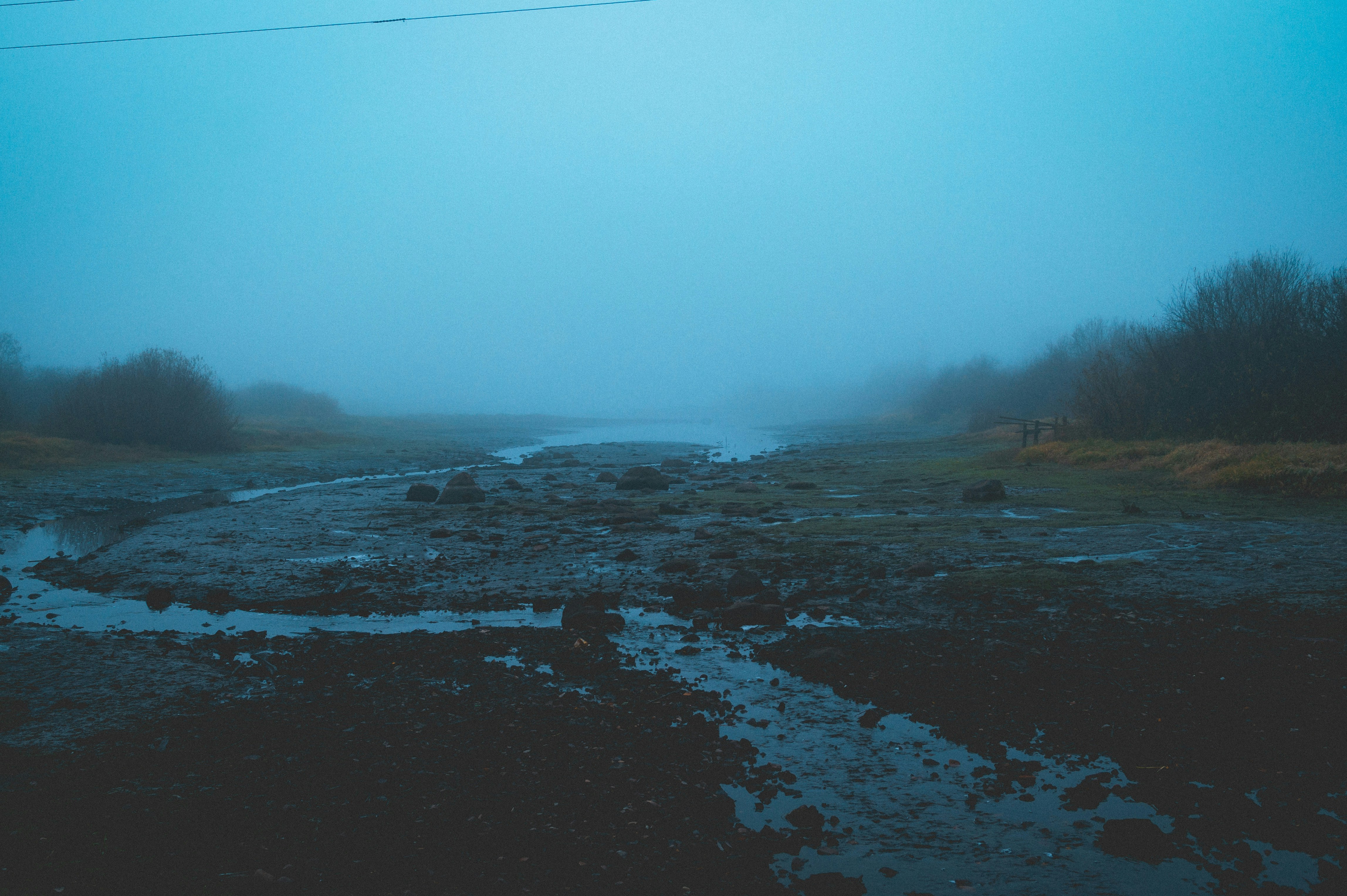 Misty river flowing through a desolate landscape