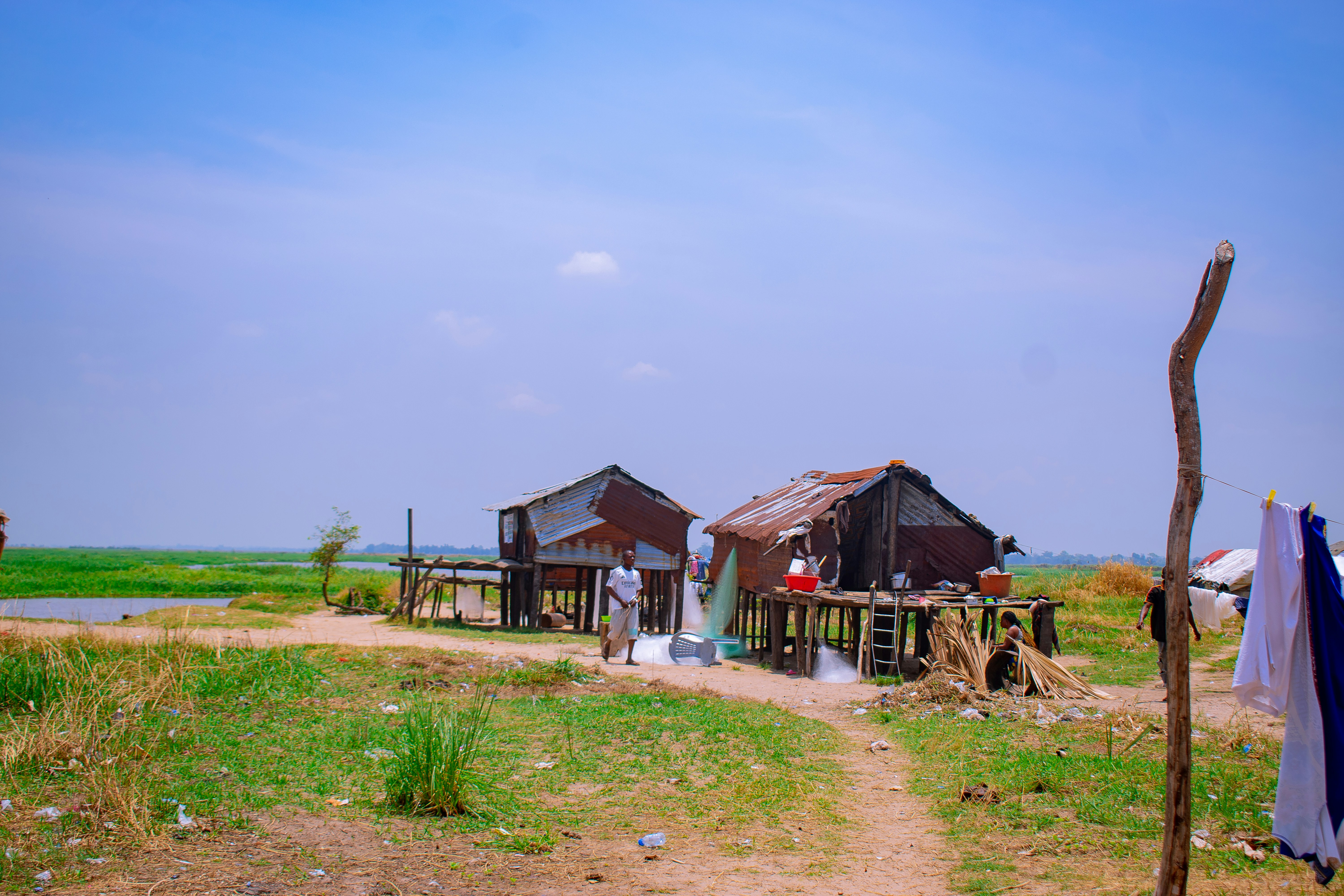 Huts on Stilts Along a Dune-Edge Coastal Plain
