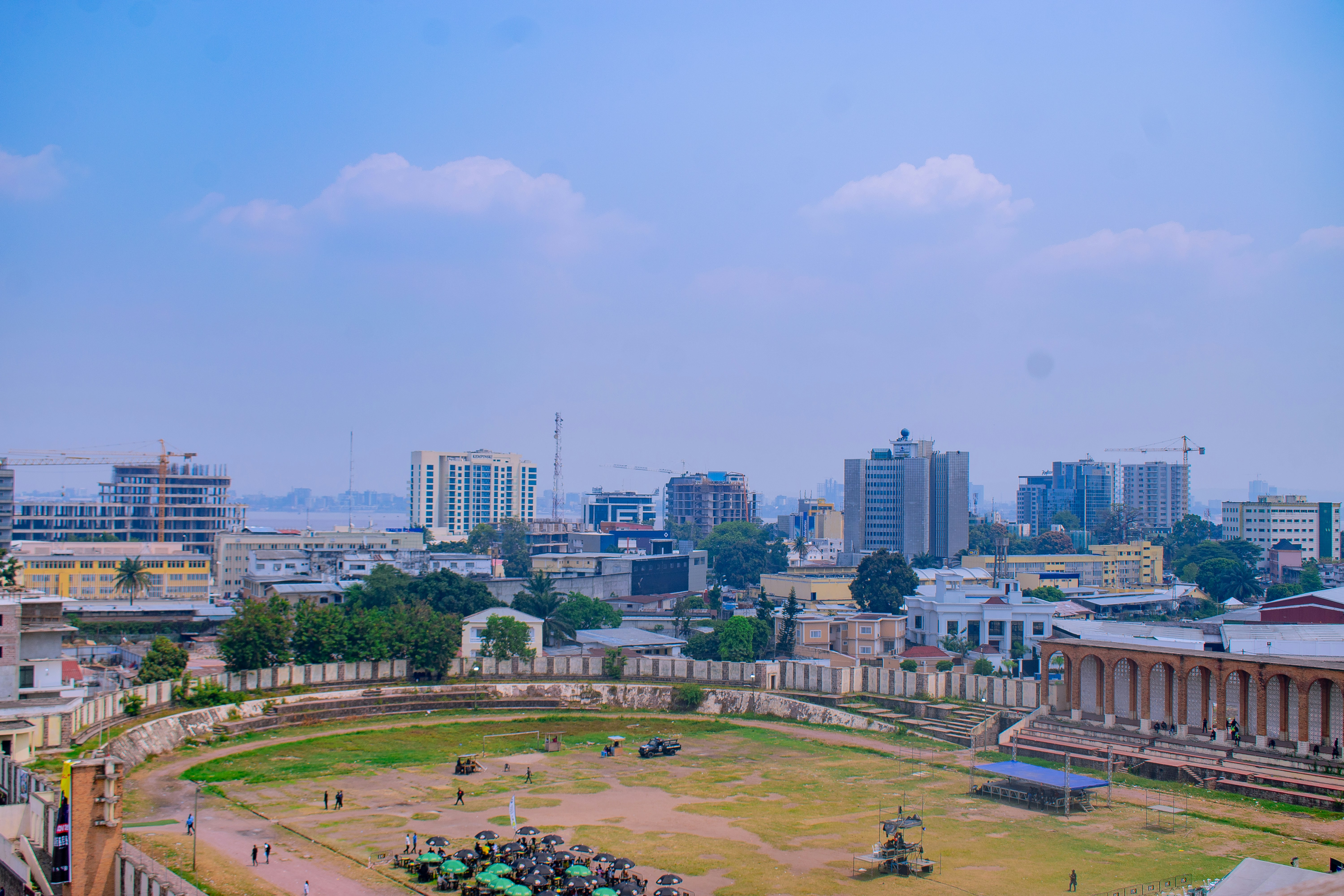 City skyline with modern buildings and a stadium.