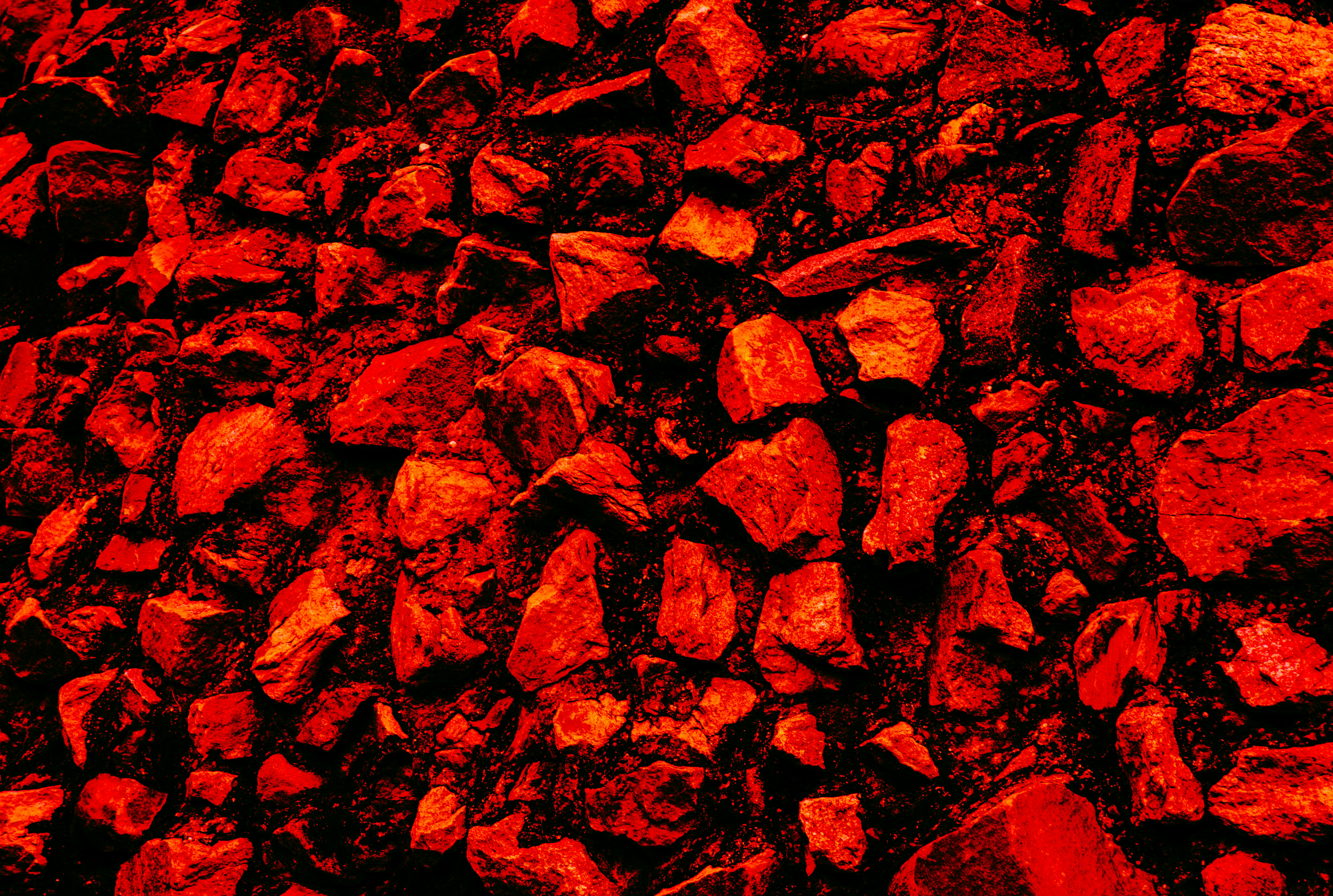 An experimental photo made from a vivid close-up of sandstone rocks. Maybe it can be used for some good album art for rock music. | Pile of glowing red hot coals