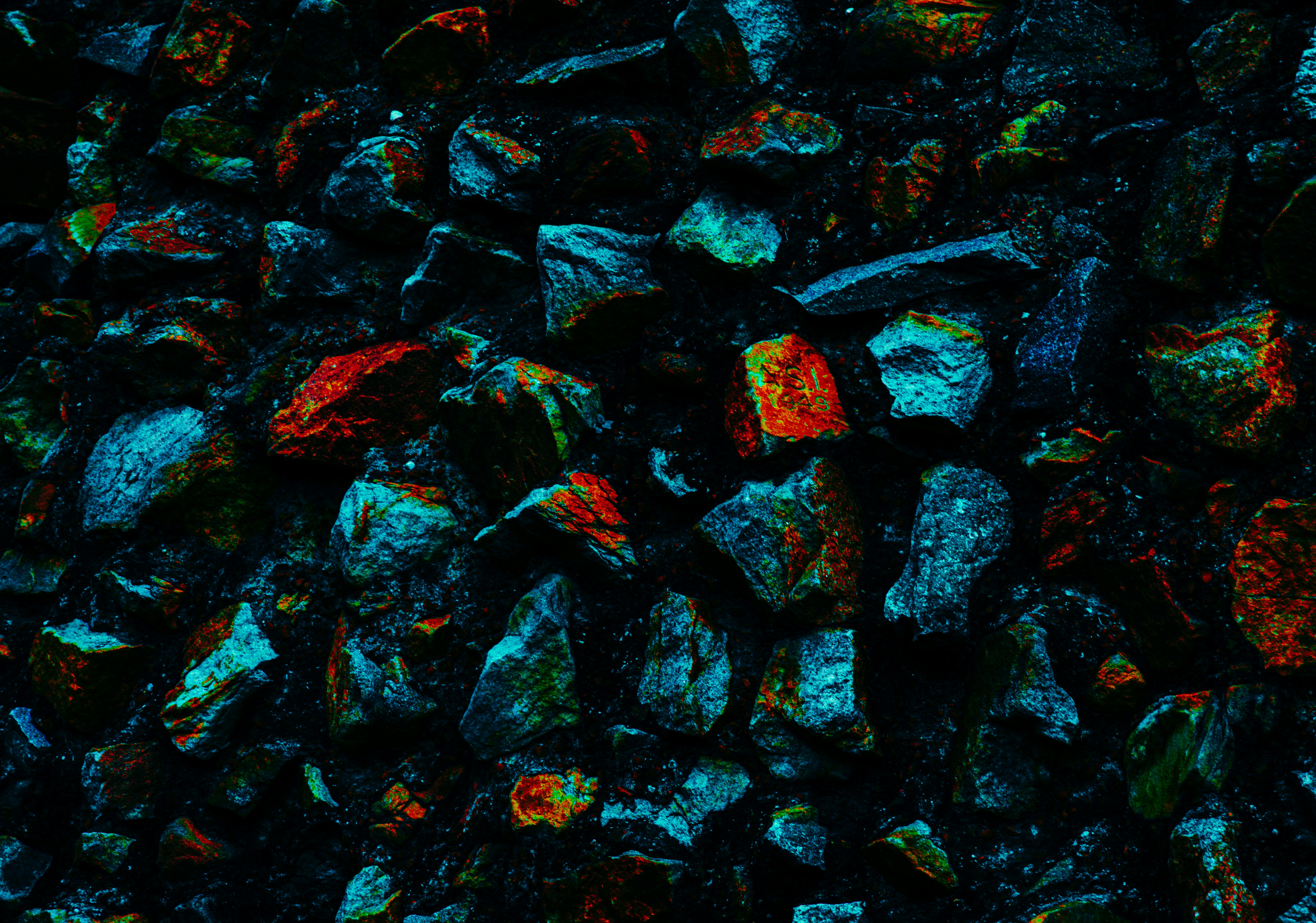 An experimental photo made from a close-up of rocks | Abstract texture of glowing embers and dark coal