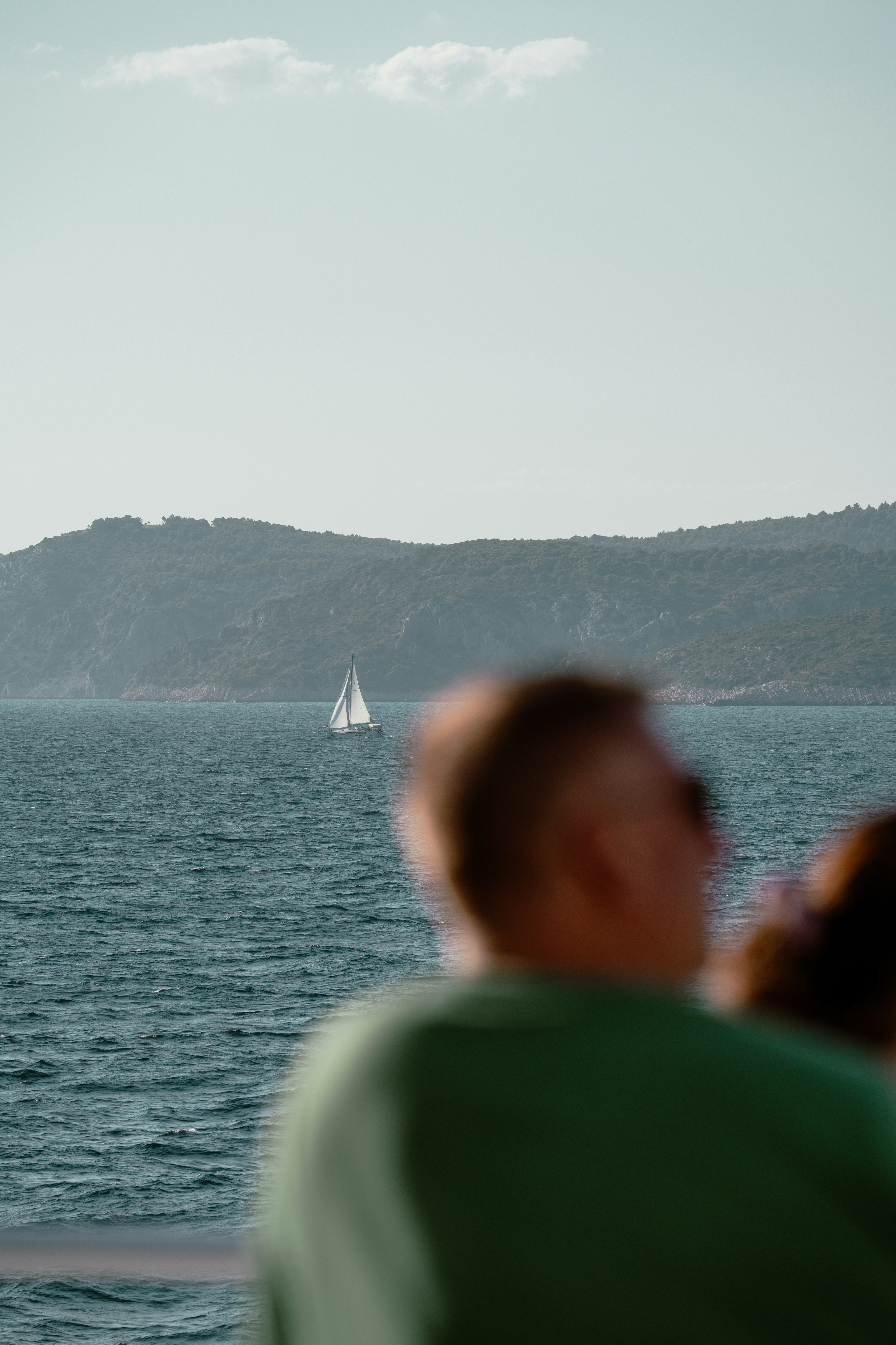Horizon Sailboat: Quiet Sea, Focus on the Distant Vessel