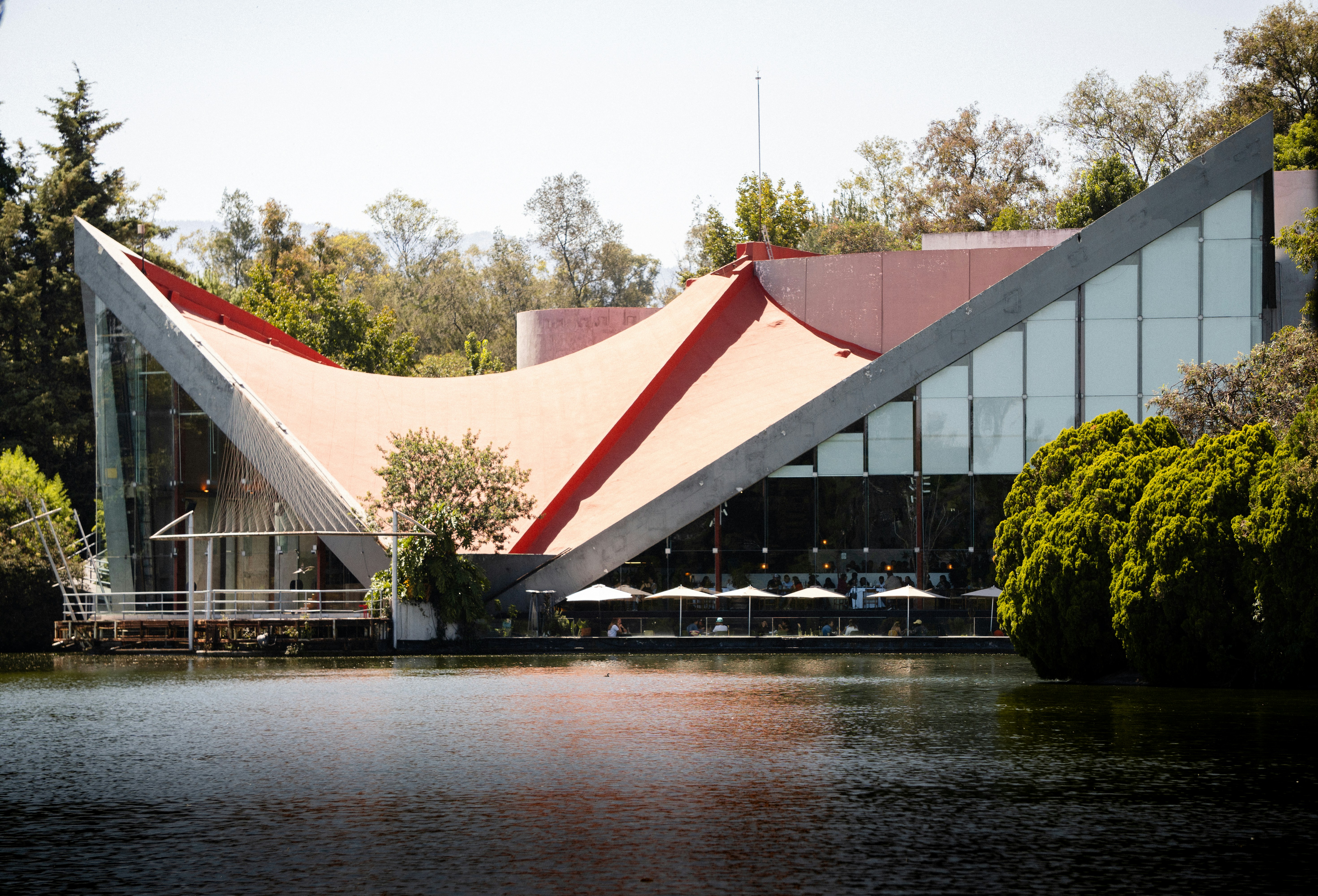 Modern building with a unique roof by a lake
