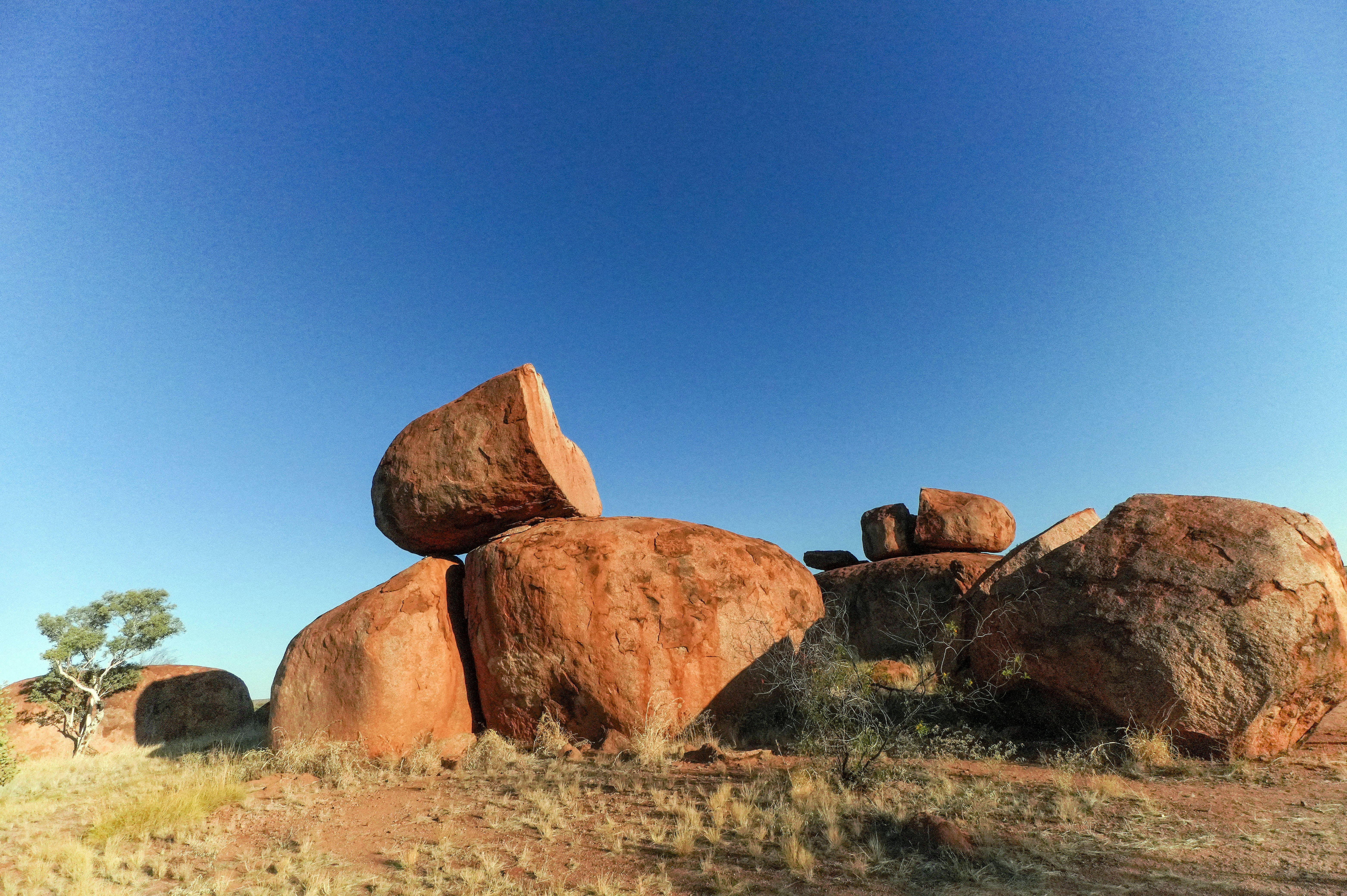 Giant rounded boulders under a clear blue sky