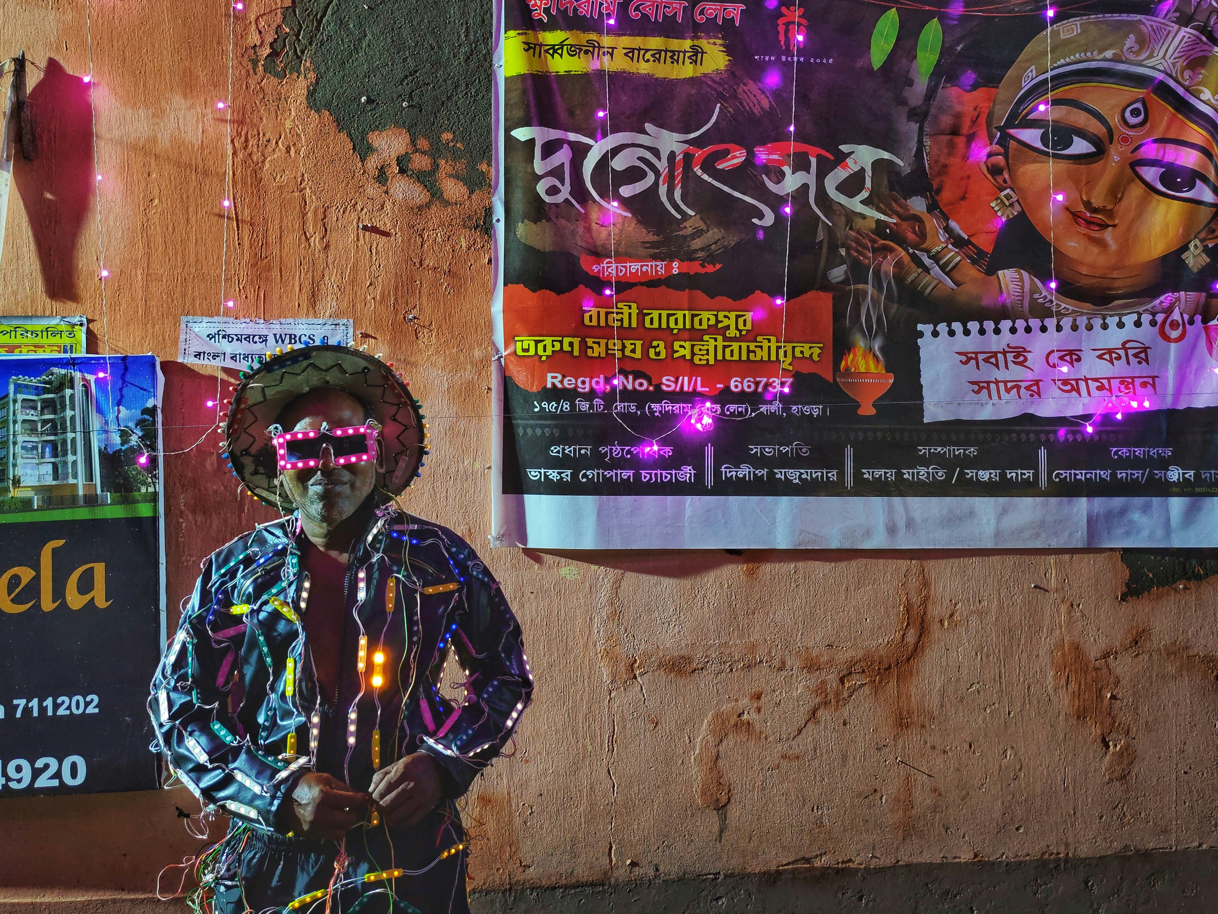 Person wearing festive lights and glasses outdoors