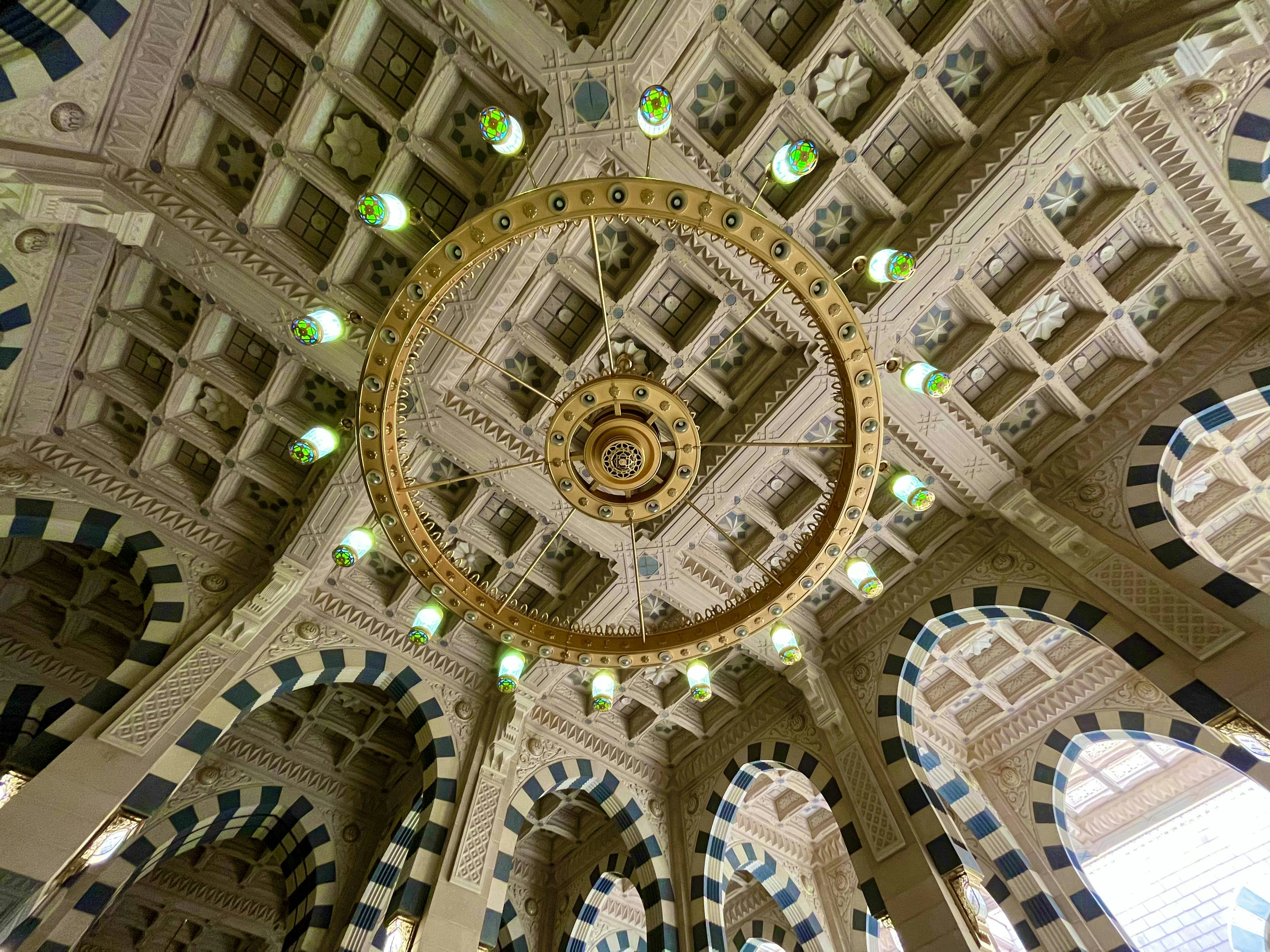 Orbital Lantern: A Circular Chandelier Framed by Moorish Arches