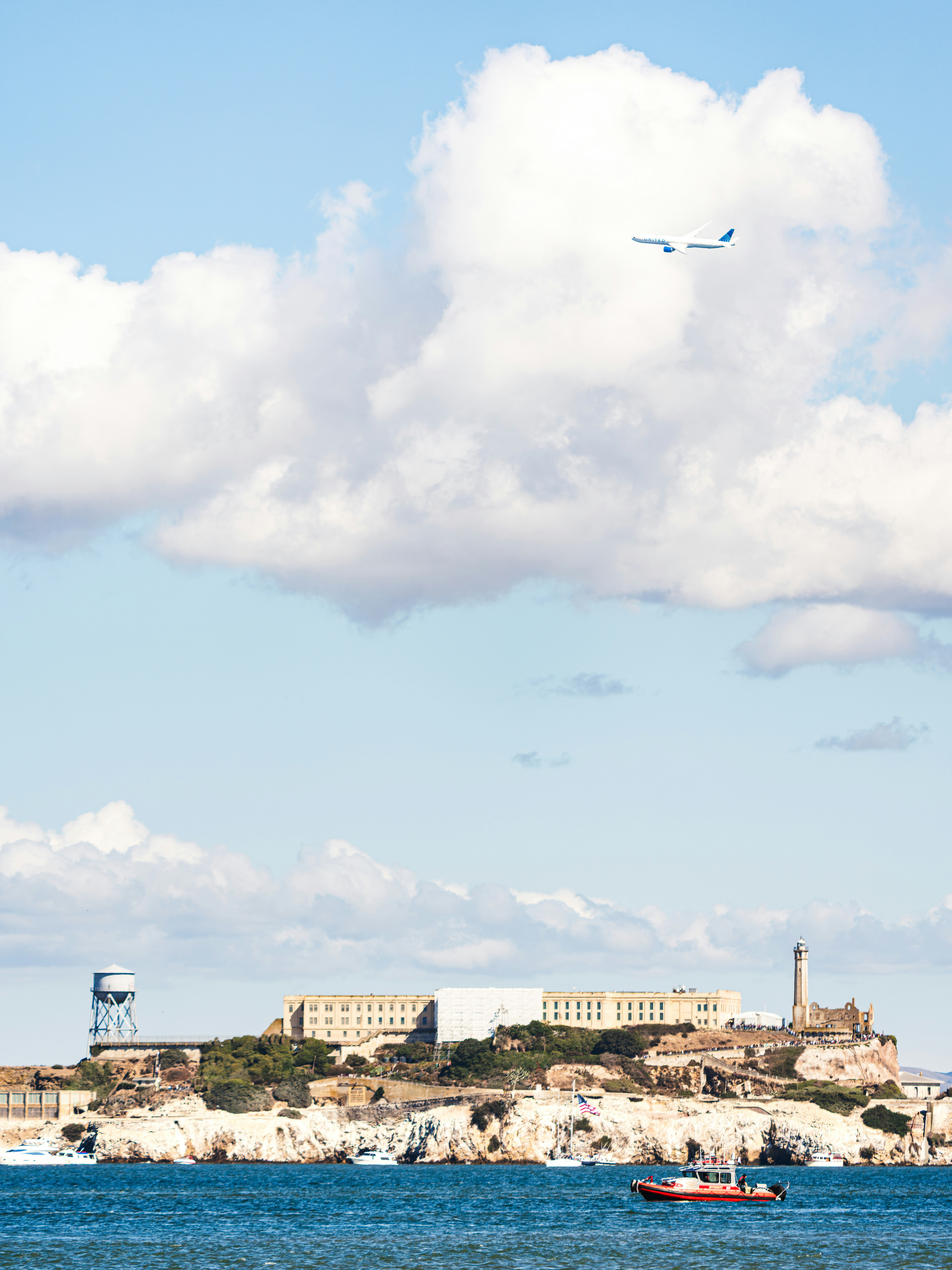 United 777 over Alcatraz Island during SF Fleet Week 2025 | Alcatraz island with lighthouse and prison buildings.