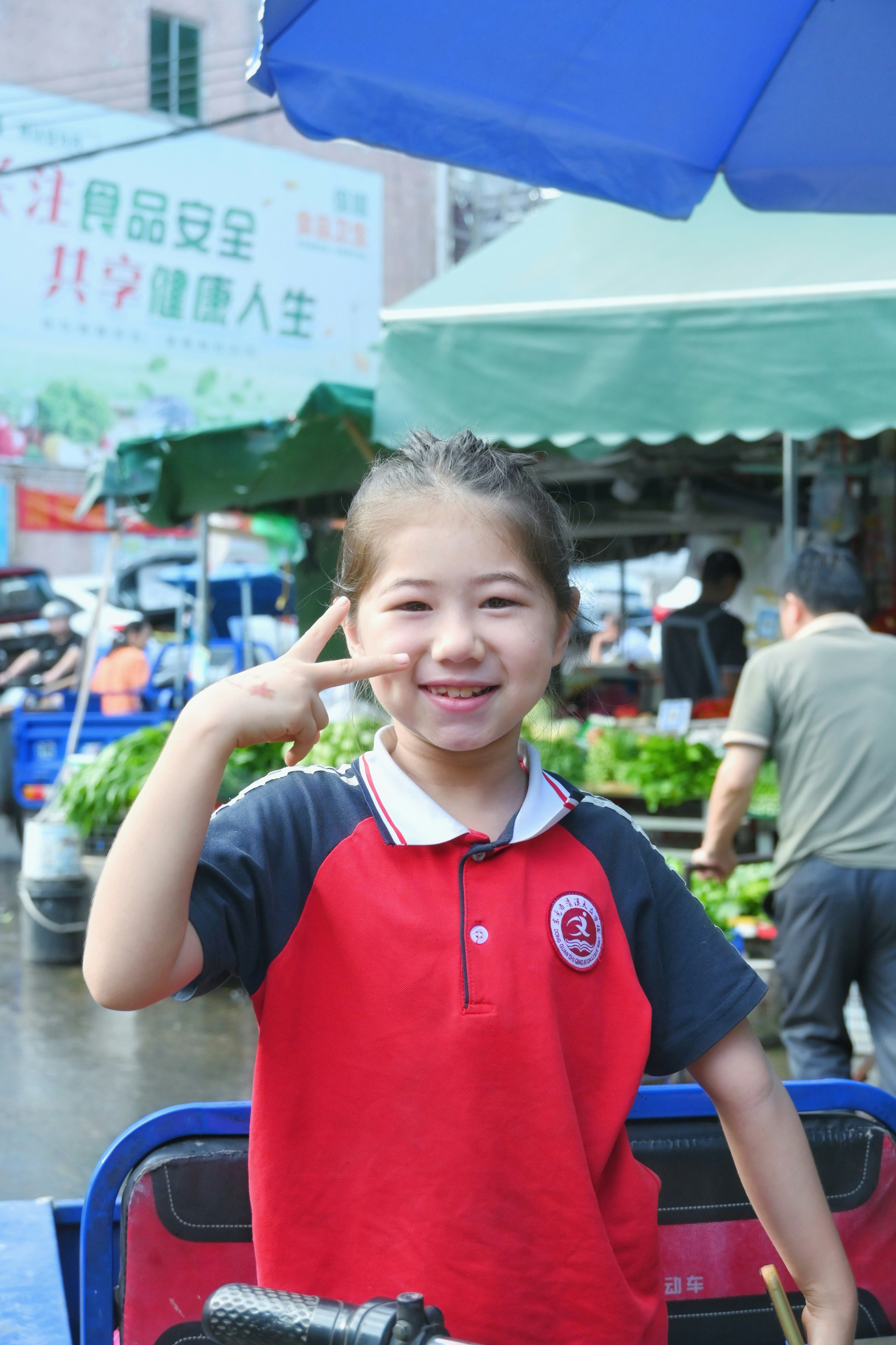 Vivid Market Smile: A Red Polo Portrait Under Street Canopies
