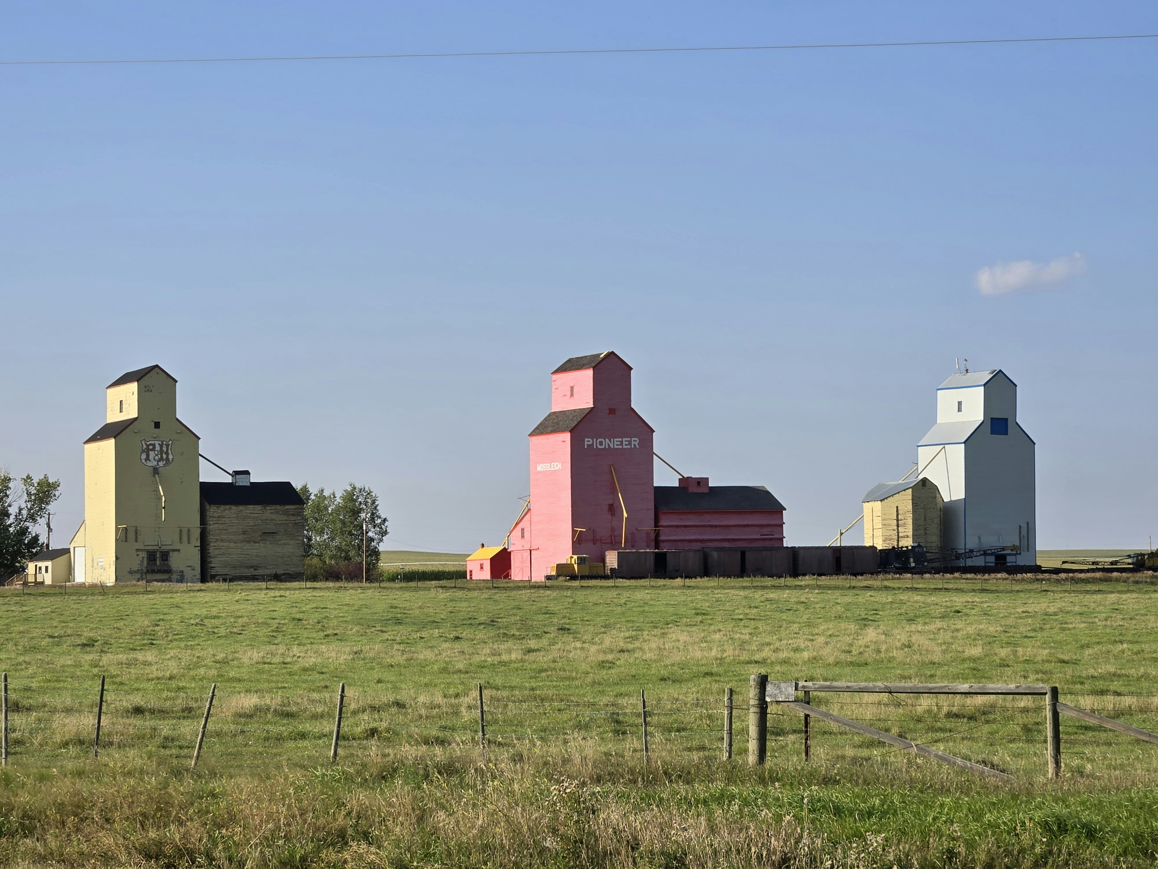 Pastel Silos on the Prairie: A Quiet Horizon of Grain Elevators