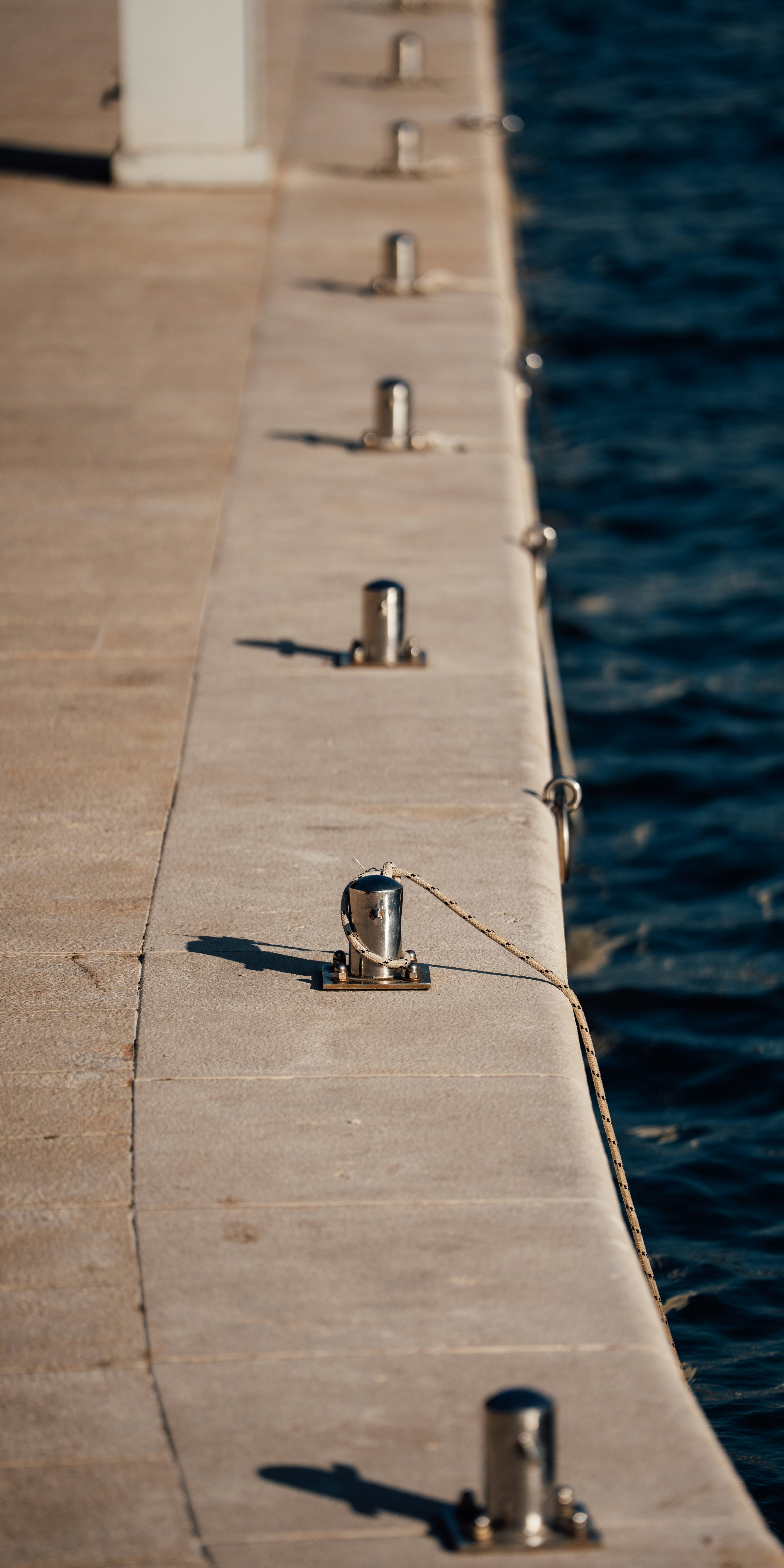 Row of bollards along a waterfront promenade photo – Free Sea Image on ...