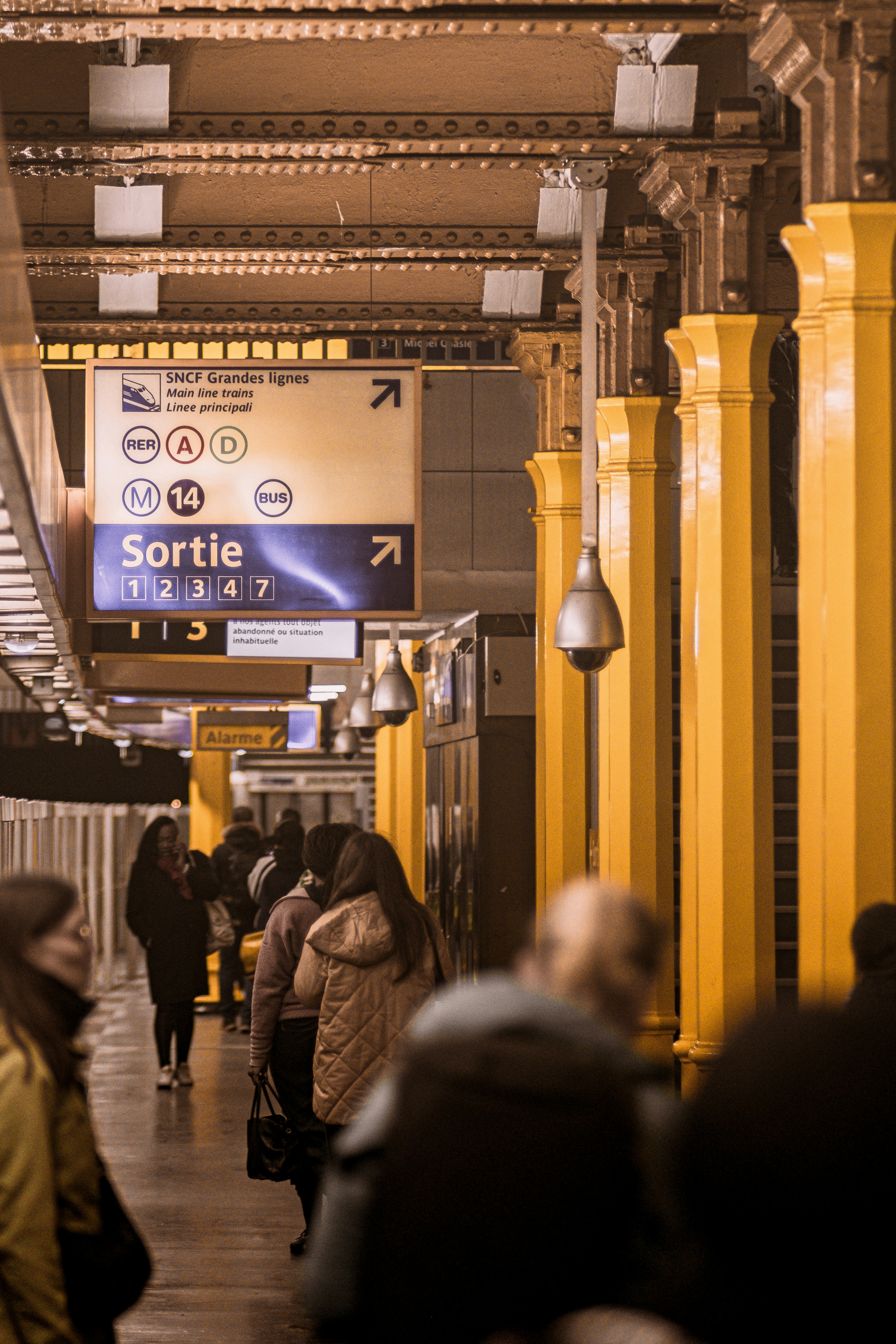 People waiting at a train station with signs photo – Free ...