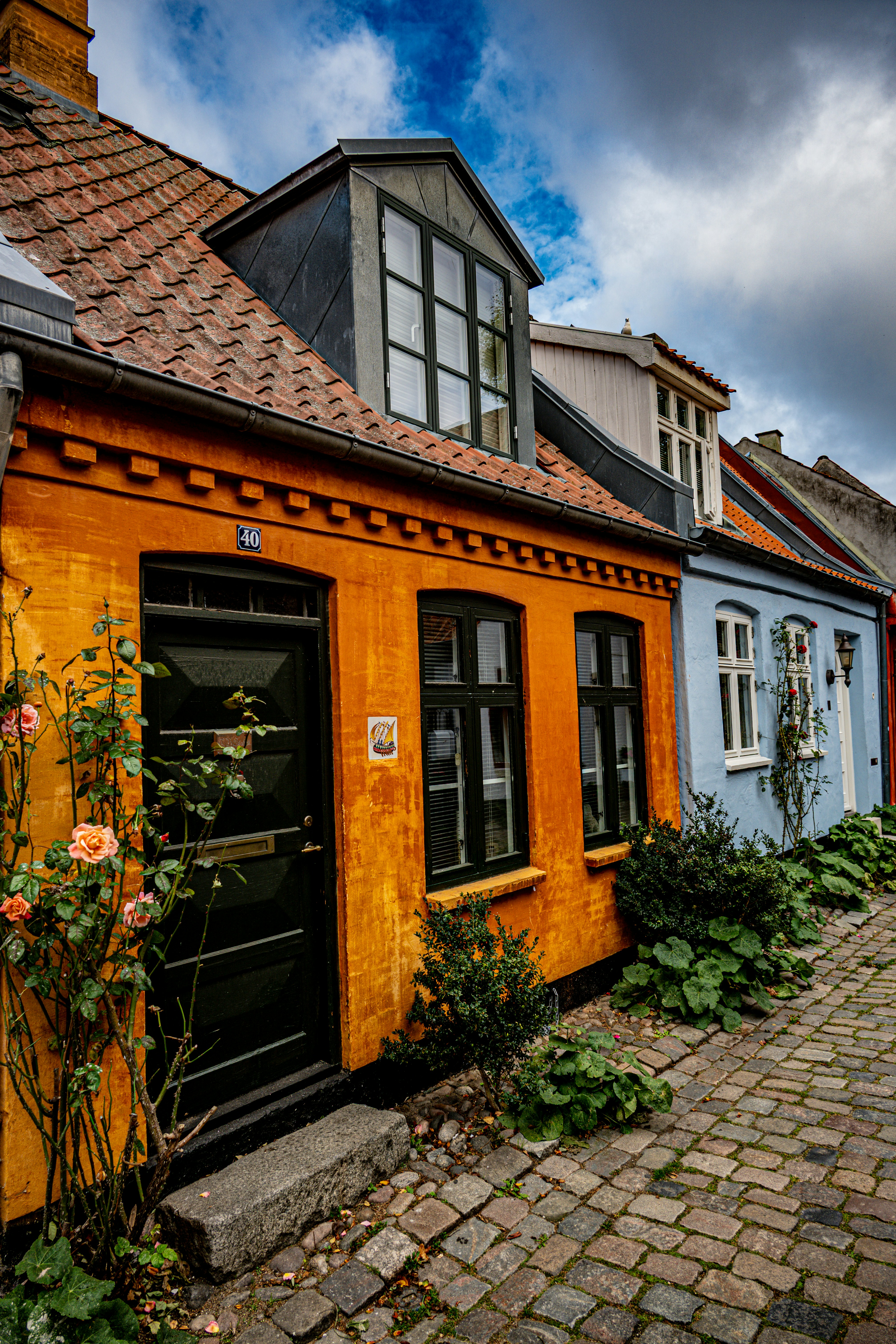 Colorful houses line a cobblestone street.